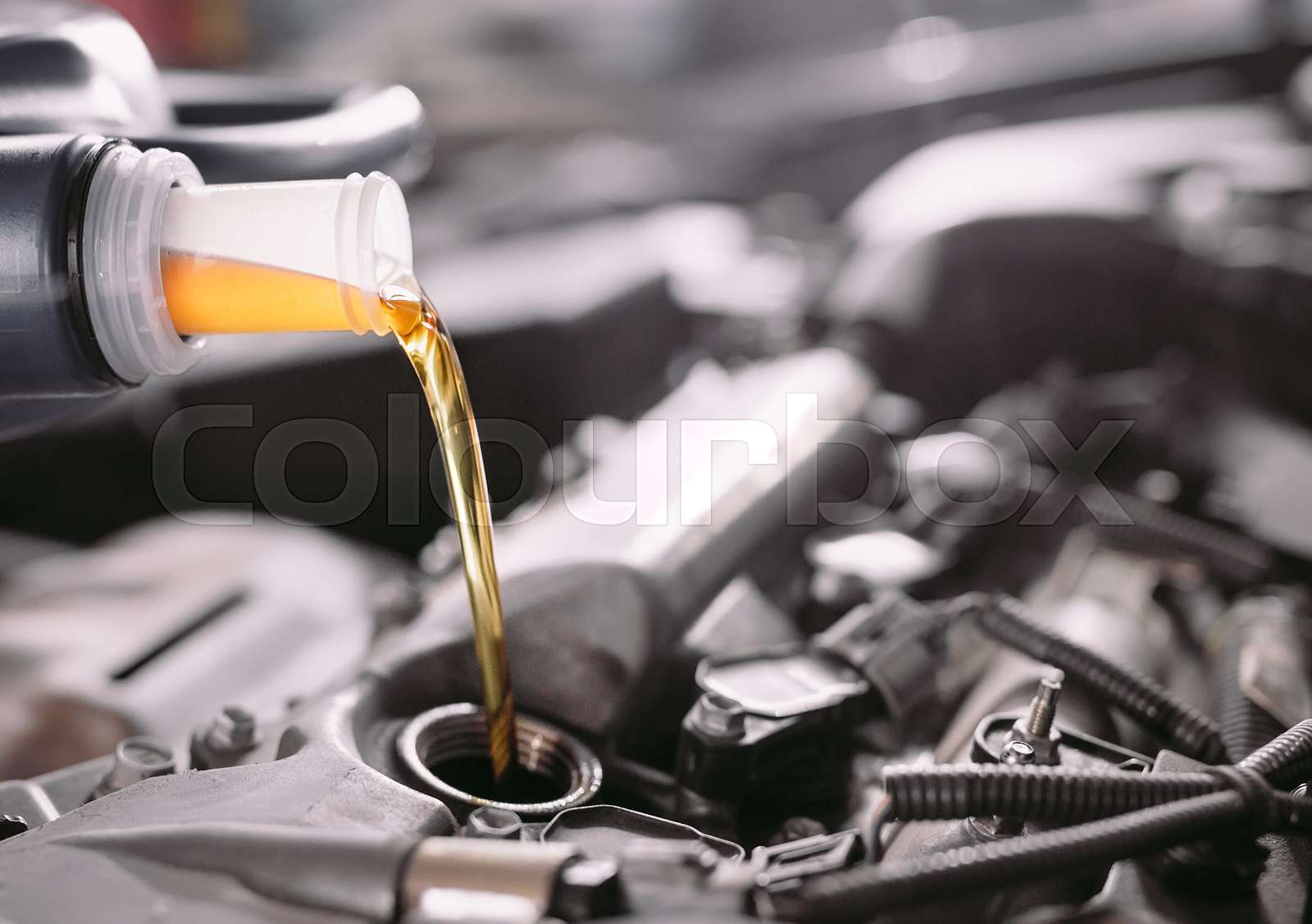 Motor oil pouring to car engine. A service station. | Stock image ...
