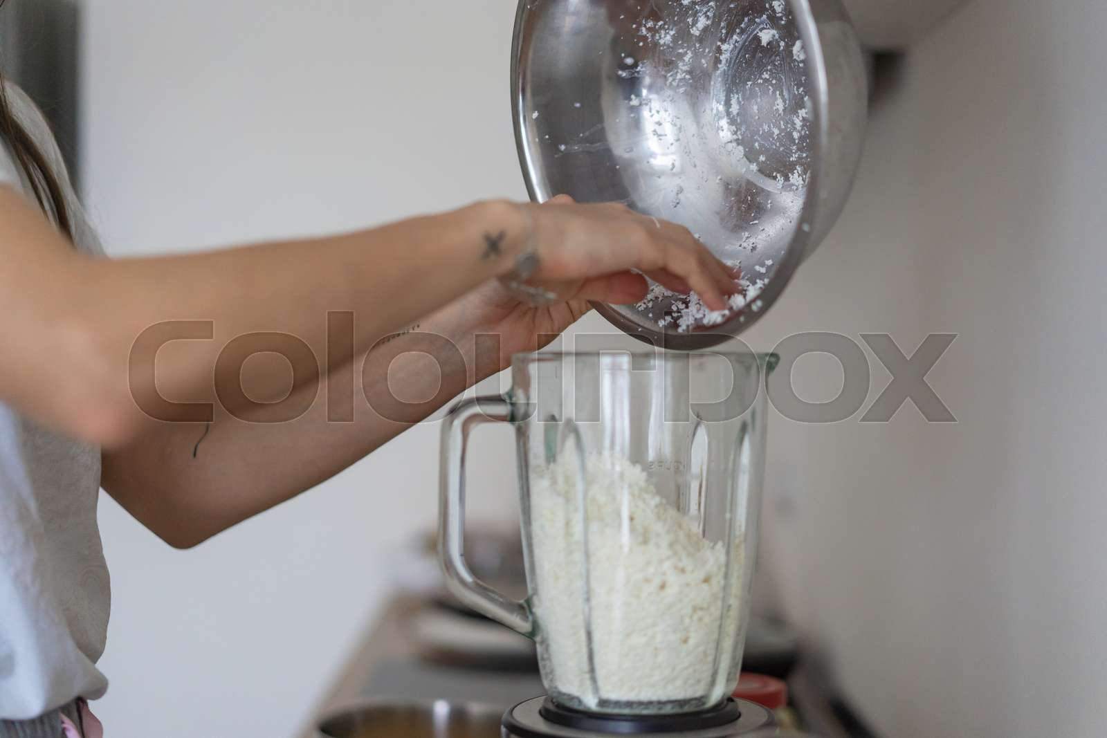 Woman pouring cottage cheese into a blender in the kitchen | Stock ...