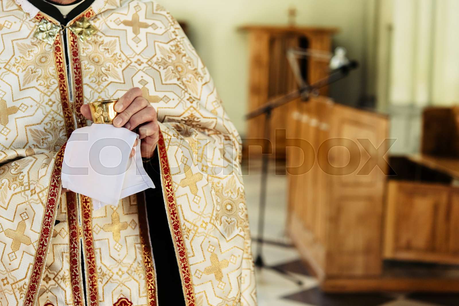 priest holding chalice for communion, wedding ceremony of happy elegant ...