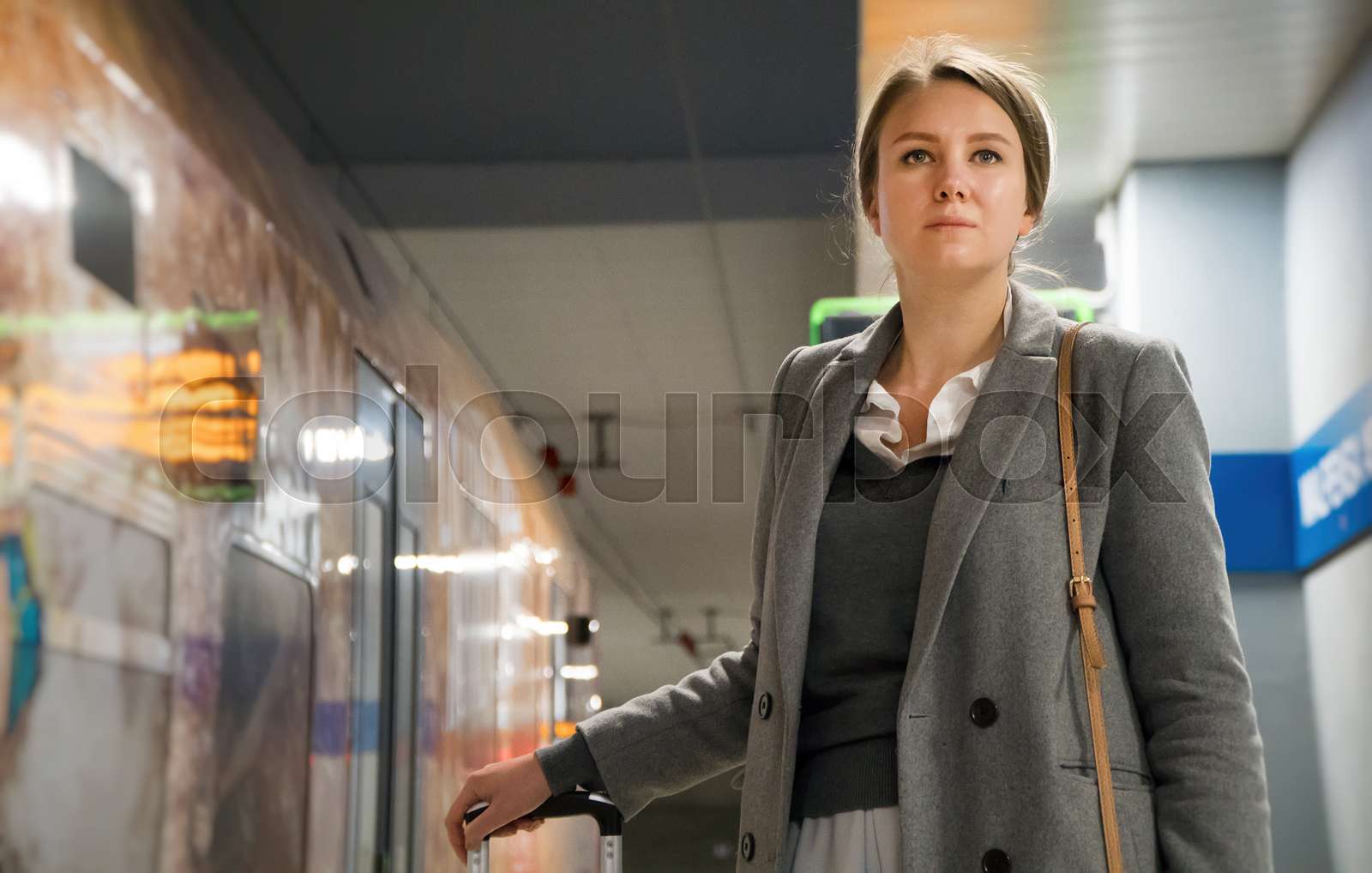 Business lady is waiting for a train at the station. | Stock image ...