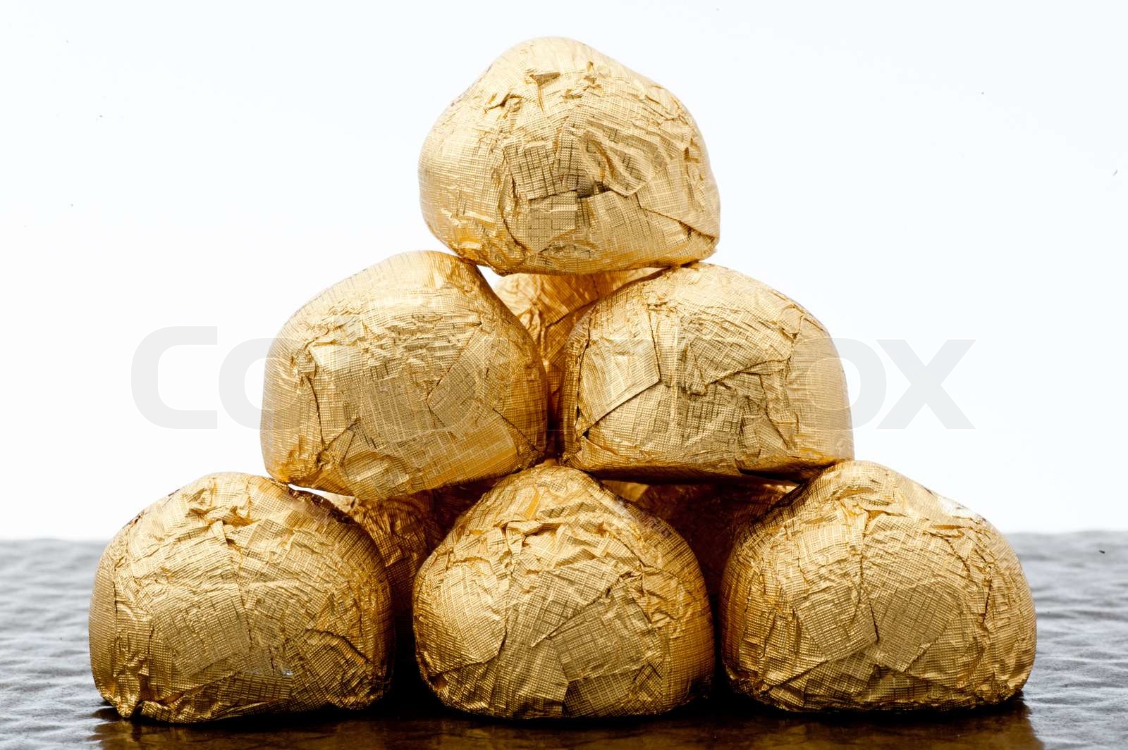 chocolates in a gold foil papper | Stock image | Colourbox