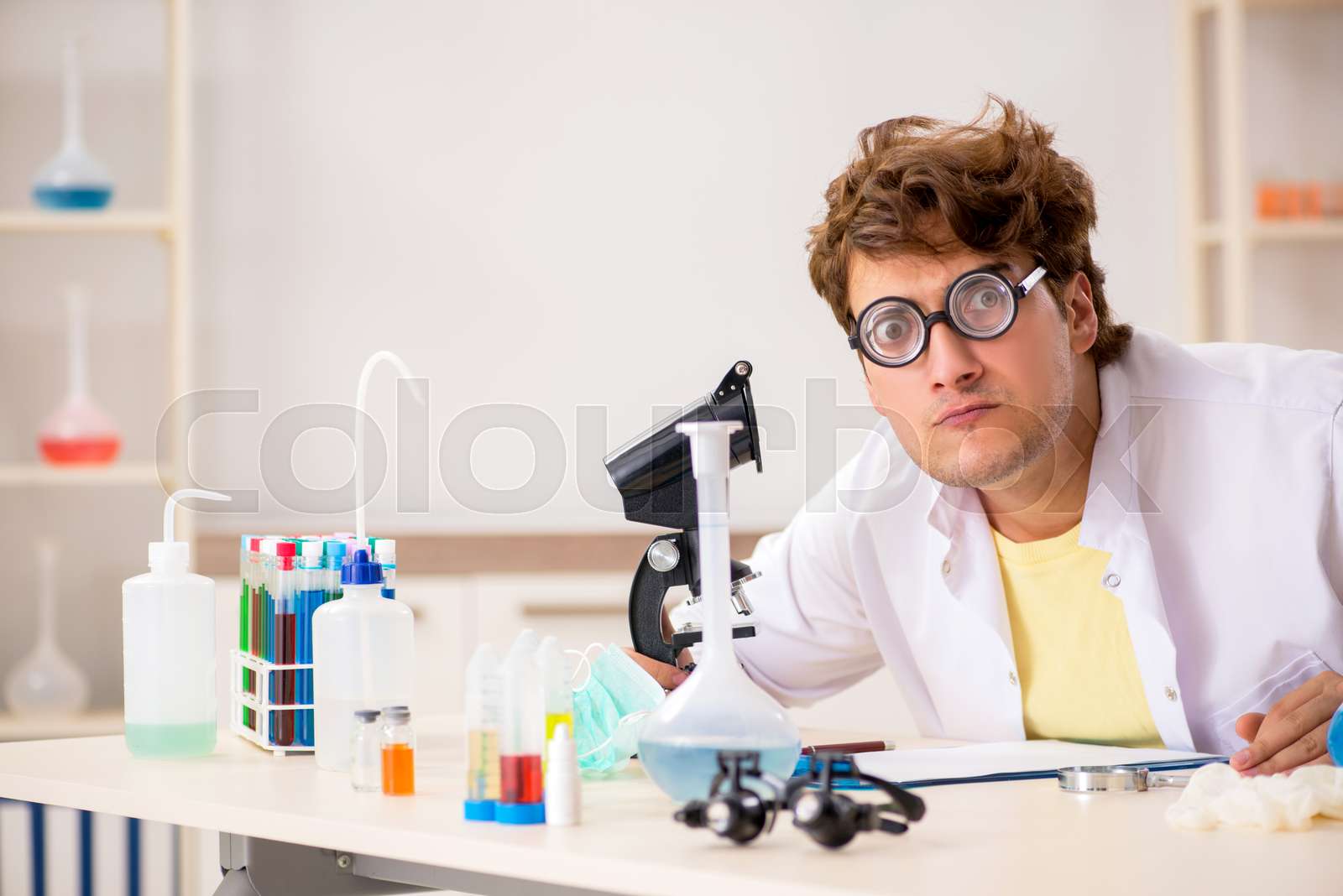 Funny crazy chemist doing experiments and tests | Stock image | Colourbox
