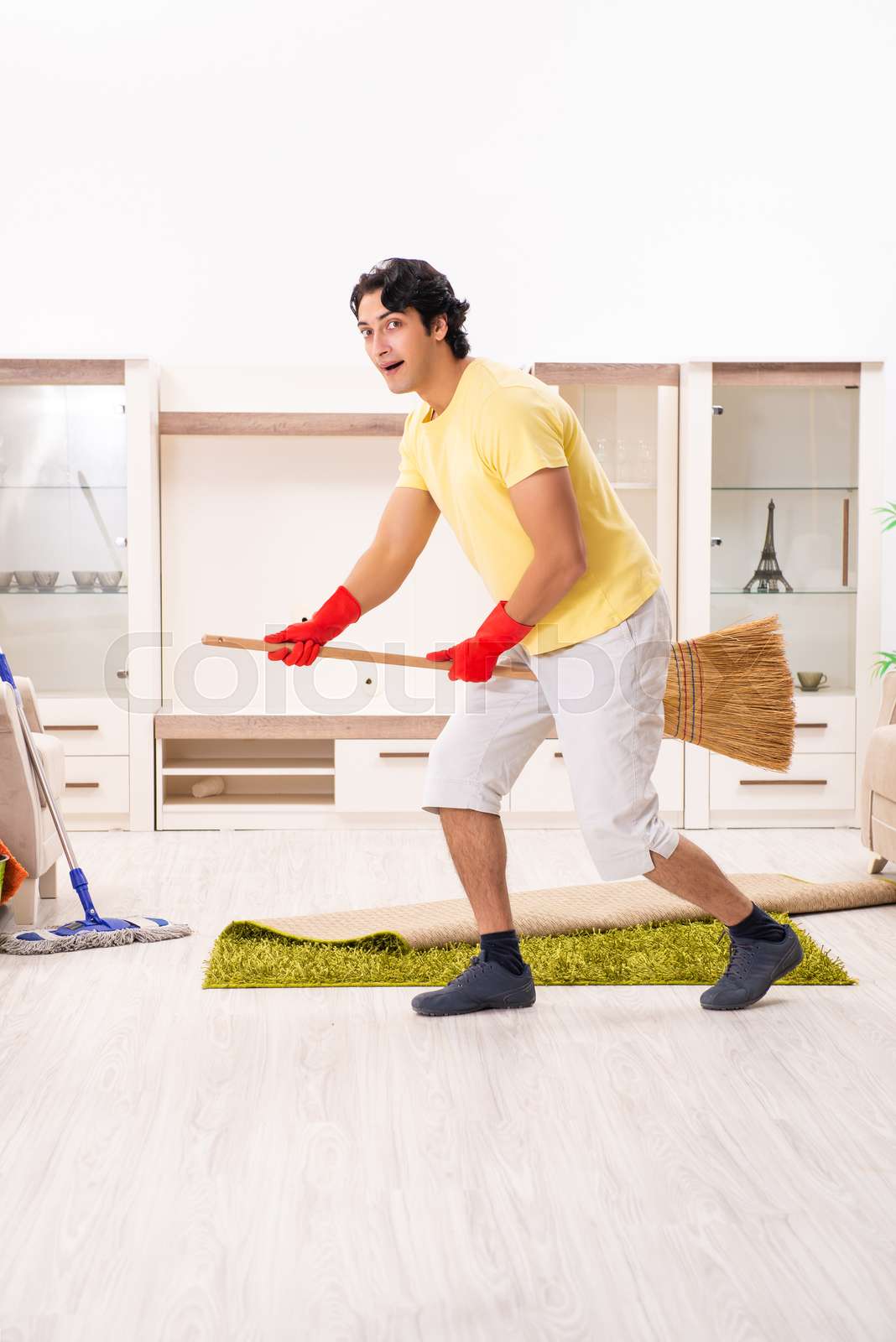 Young handsome man doing housework | Stock image | Colourbox
