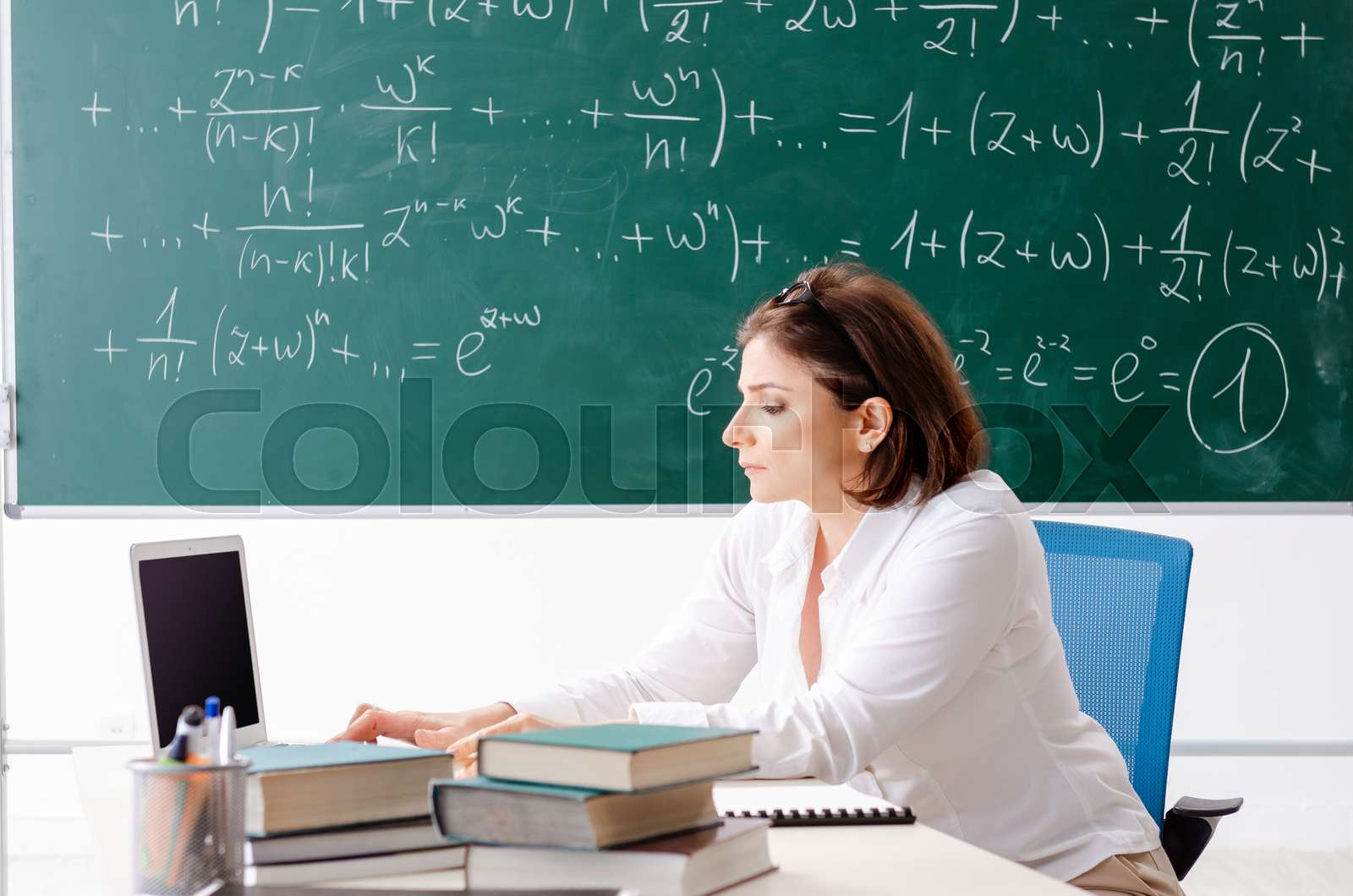 Female math teacher in front of the chalkboard | Stock image | Colourbox