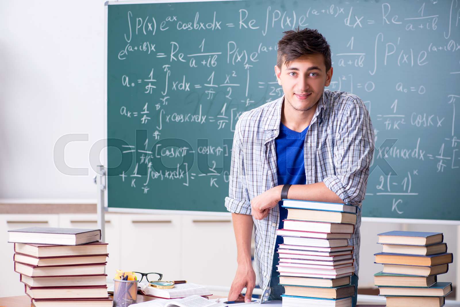 Young male student studying math at school | Stock image | Colourbox