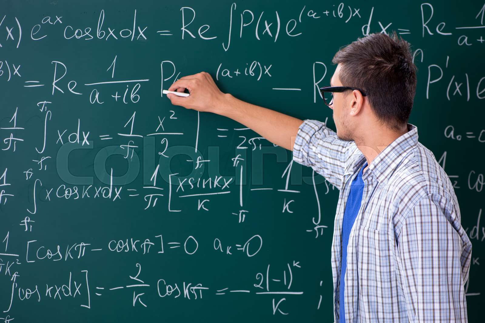 Young male student studying math at school | Stock image | Colourbox