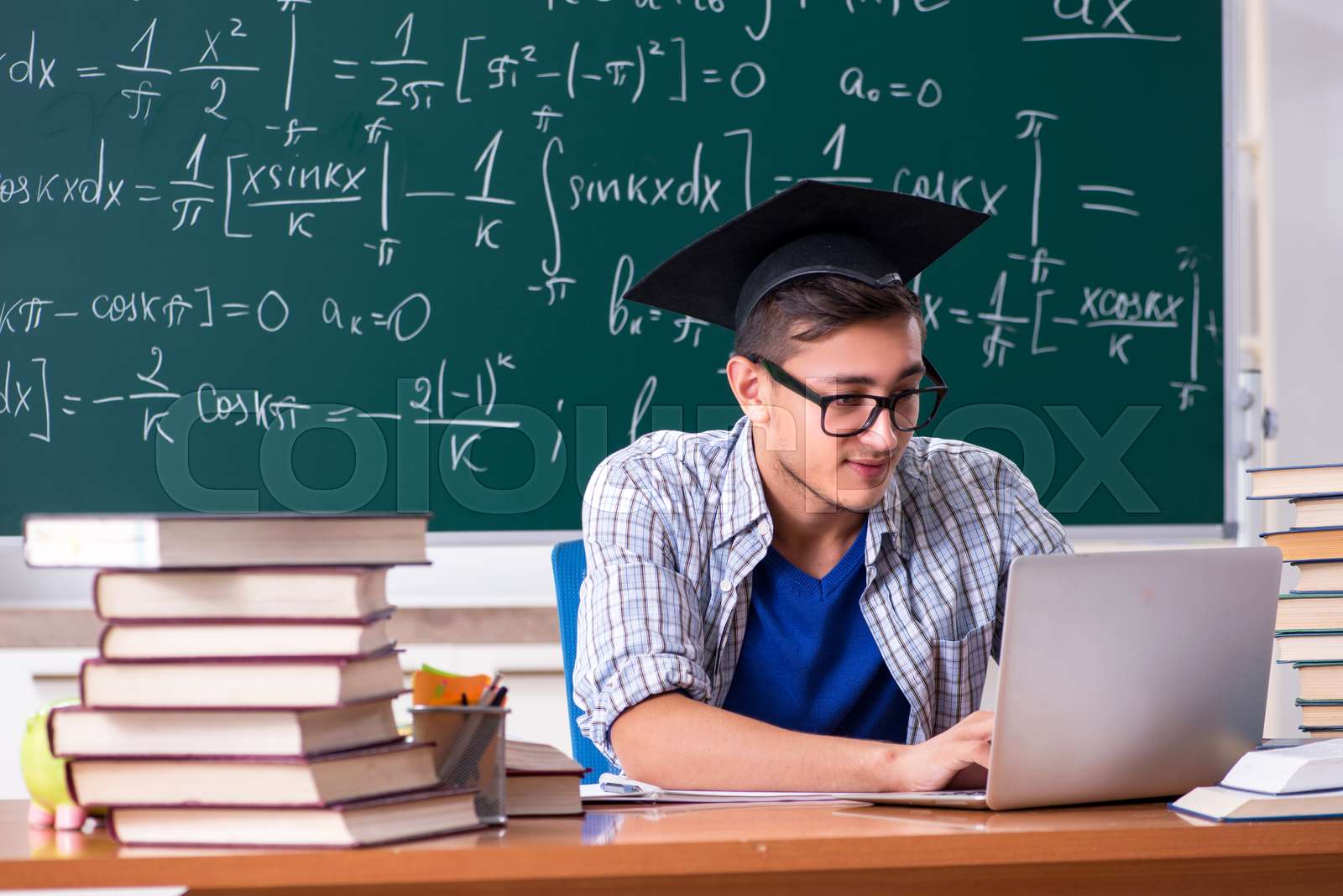 Young male student studying math at school | Stock image | Colourbox