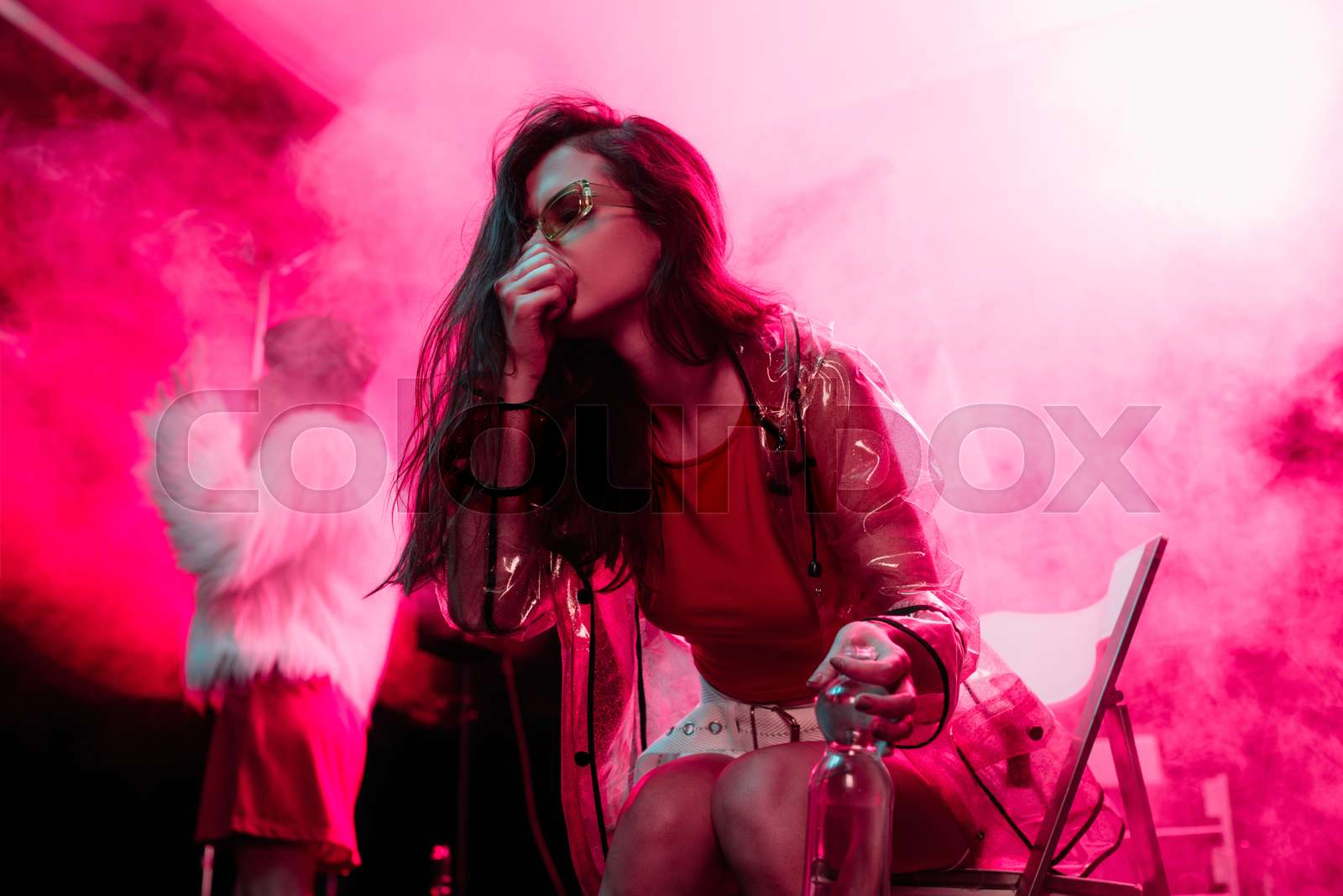 sick girl sitting with bottle of water in nightclub | Stock image ...