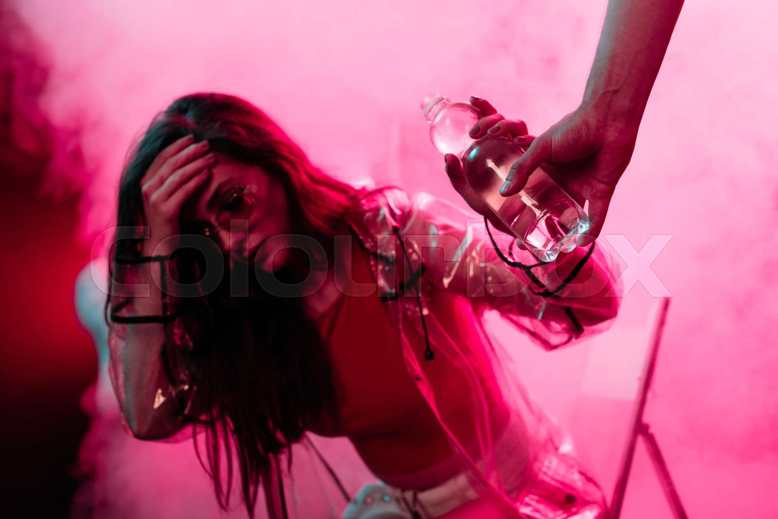sick girl headache taking bottle of water in nightclub | Stock image ...