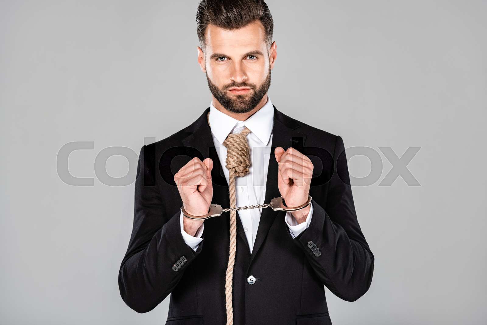 businessman in black suit and handcuffs with noose on neck isolated on ...