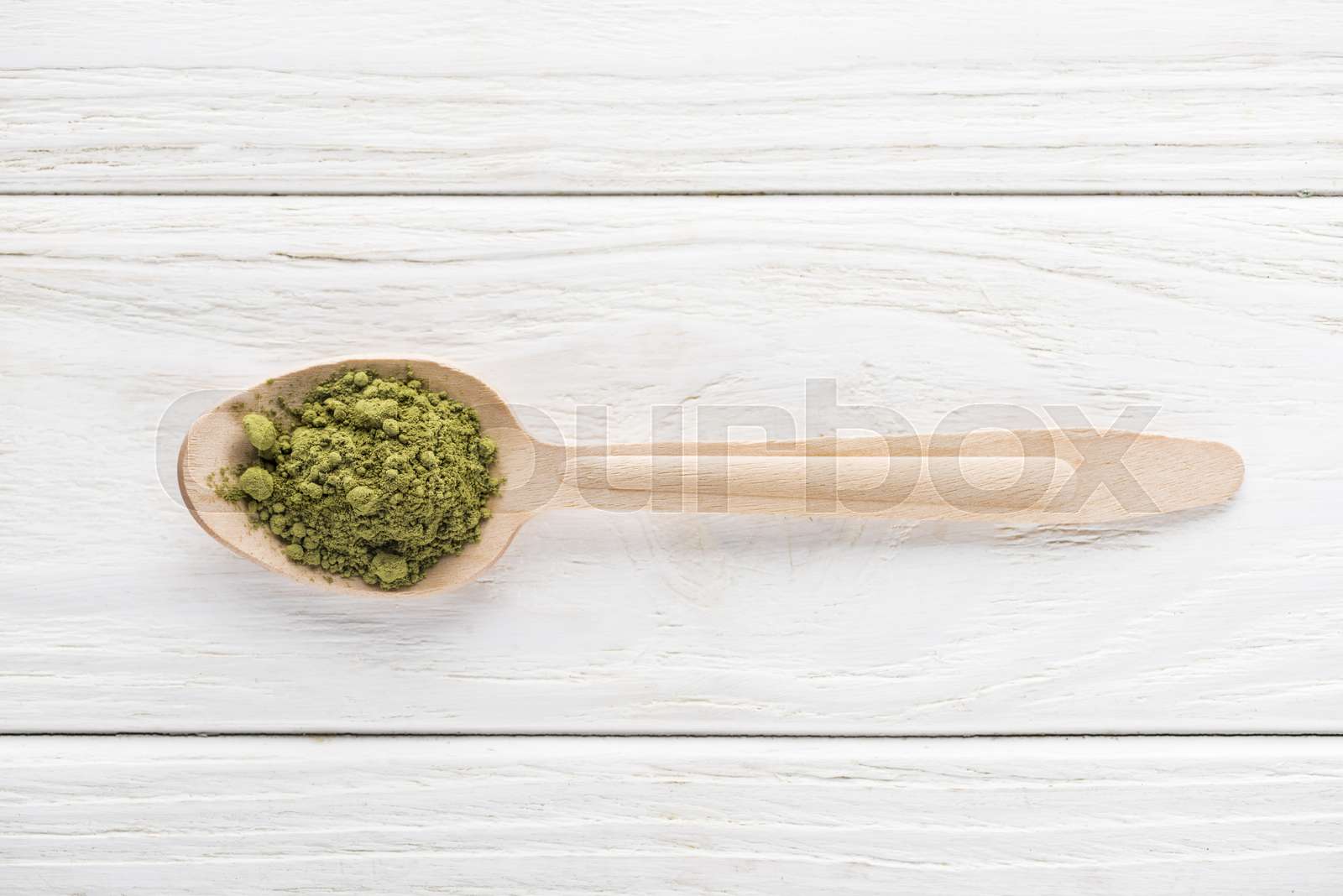 top view of wooden spoon with powder of green matcha tea | Stock image ...