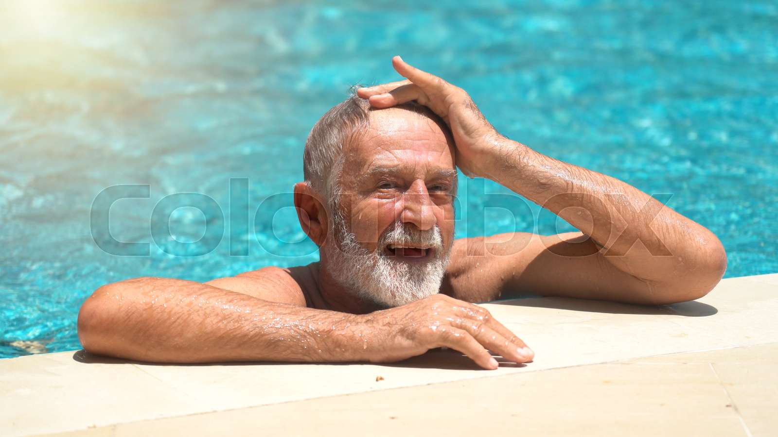 Senior man swimming in swimming pool | Stock image | Colourbox