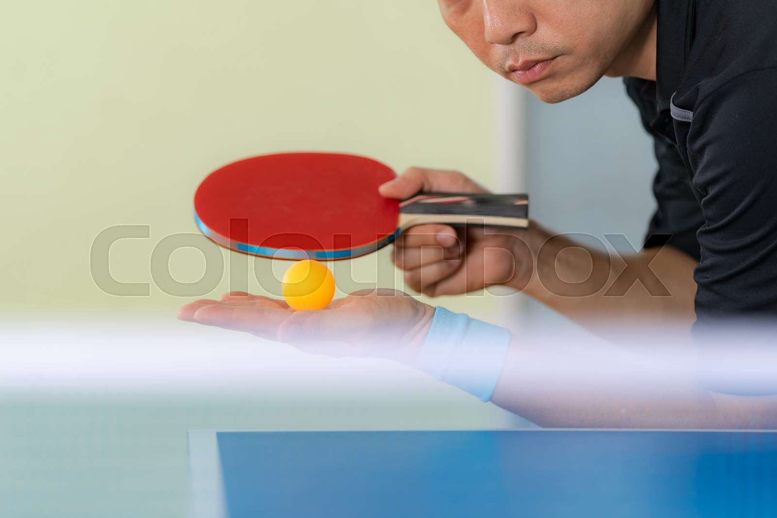 Ping pong table, Male playing table tennis with racket and ball in a ...