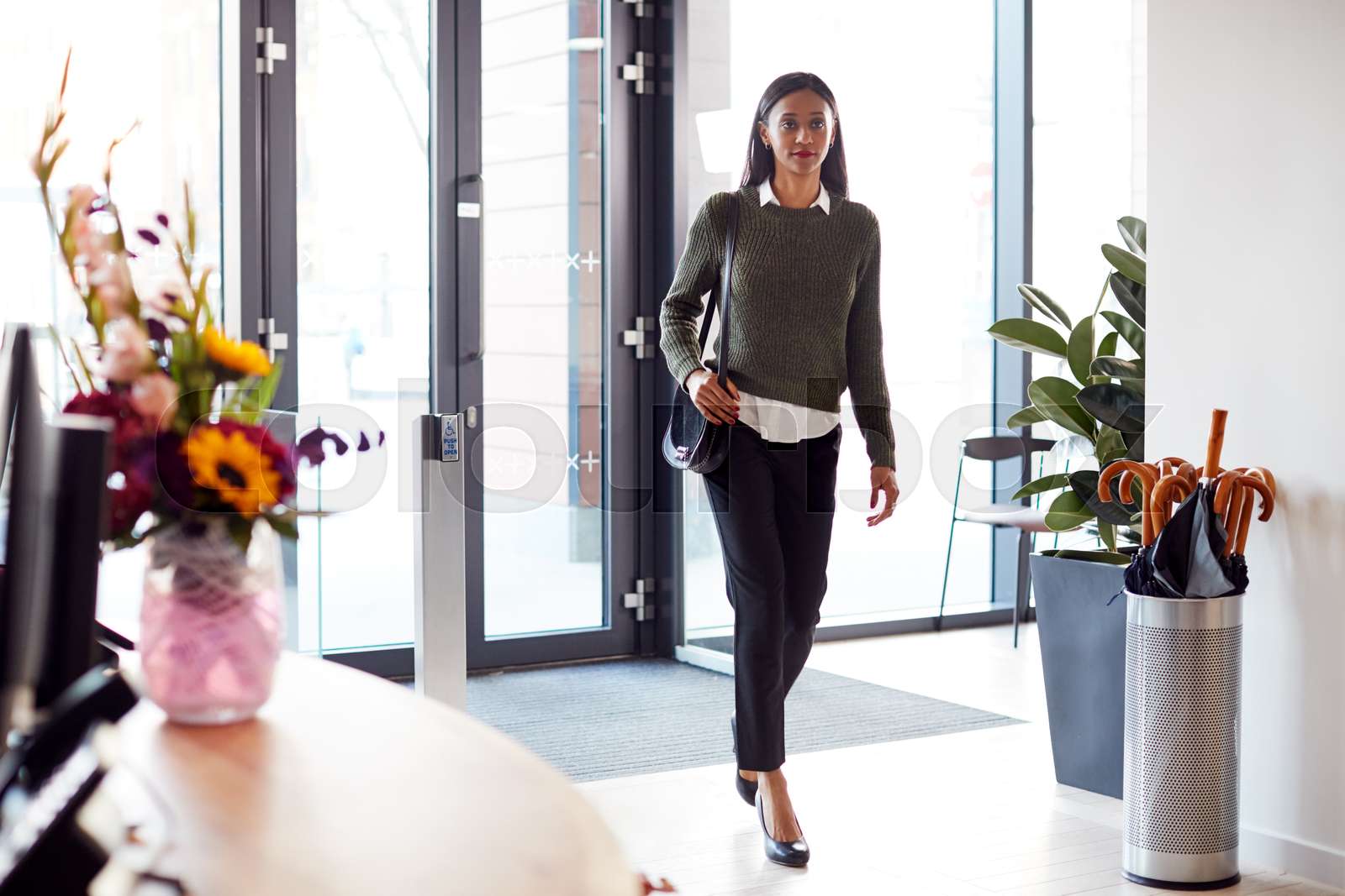 Businesswoman Arriving For Work At Office Walking Through Door | Stock ...