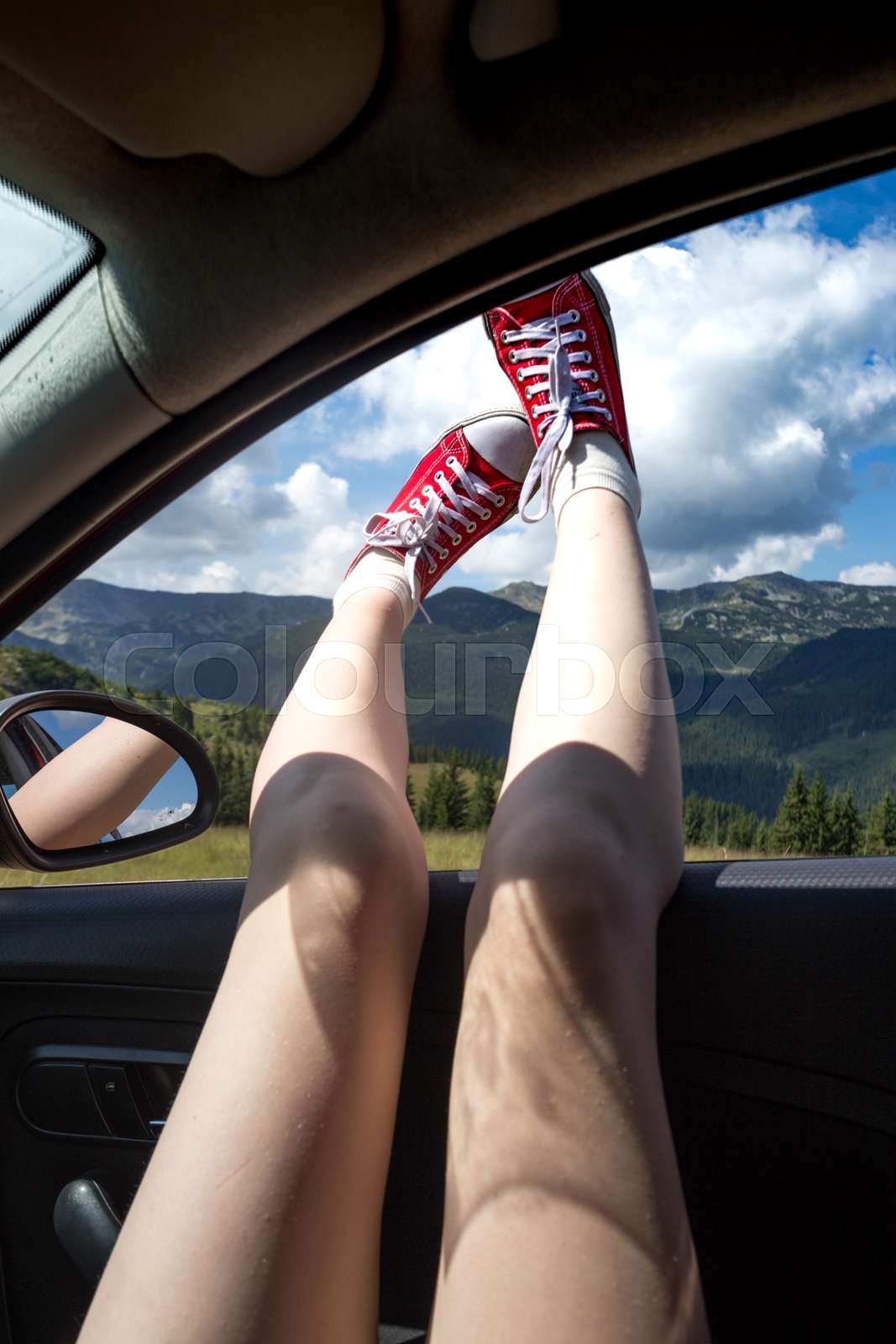 Girl legs sticking out of the car | Stock image | Colourbox