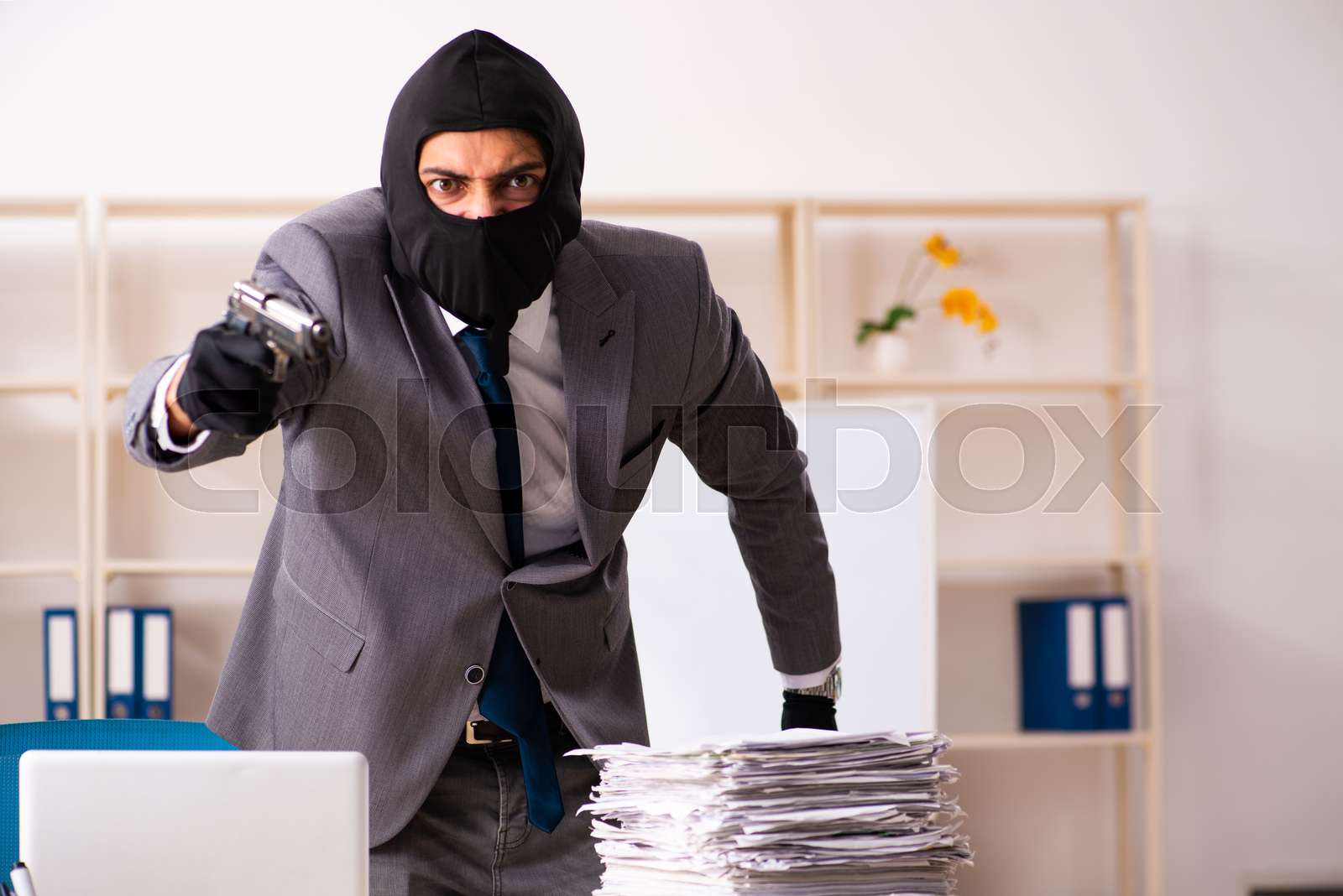 Male gangster stealing information from the office | Stock image ...