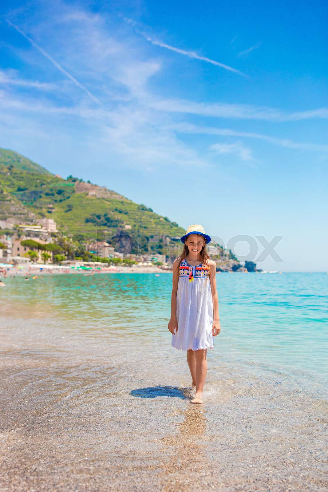 Portrait of adorable little girl at beach during summer vacation ...