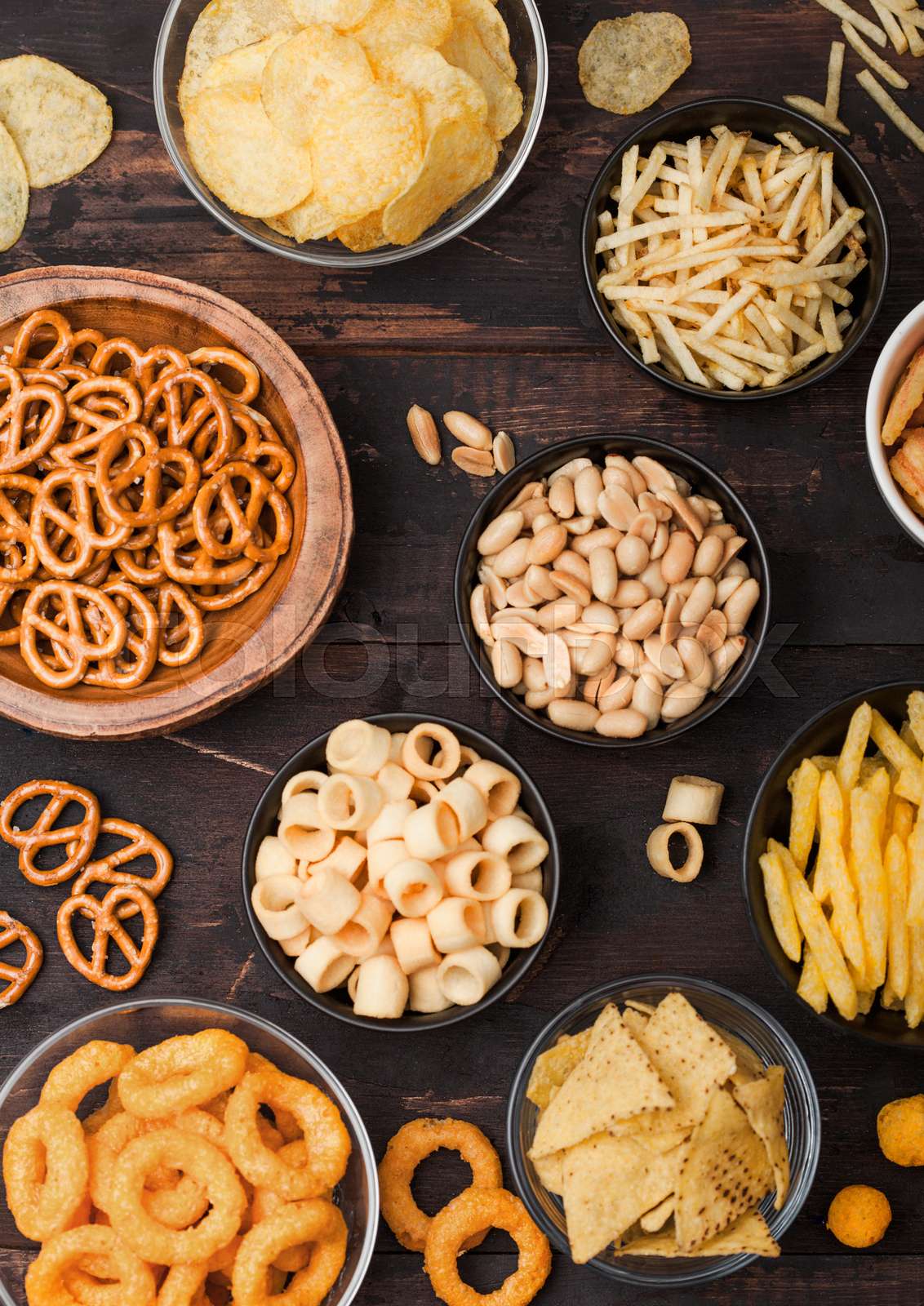 All classic potato snacks with peanuts, popcorn and onion rings and ...
