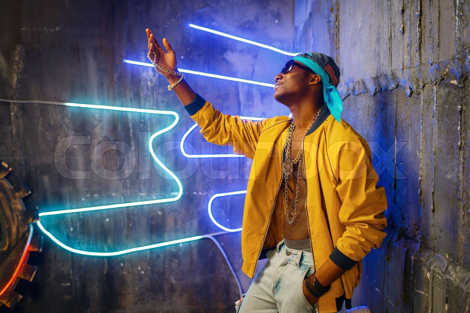 Black rapper in underpass neon light on background | Stock image ...