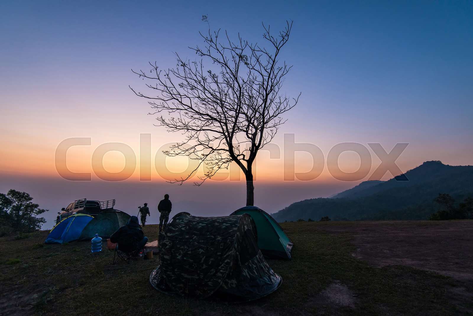 Tent area on sunset or sunrise on hill / Landscape camping tents in the ...