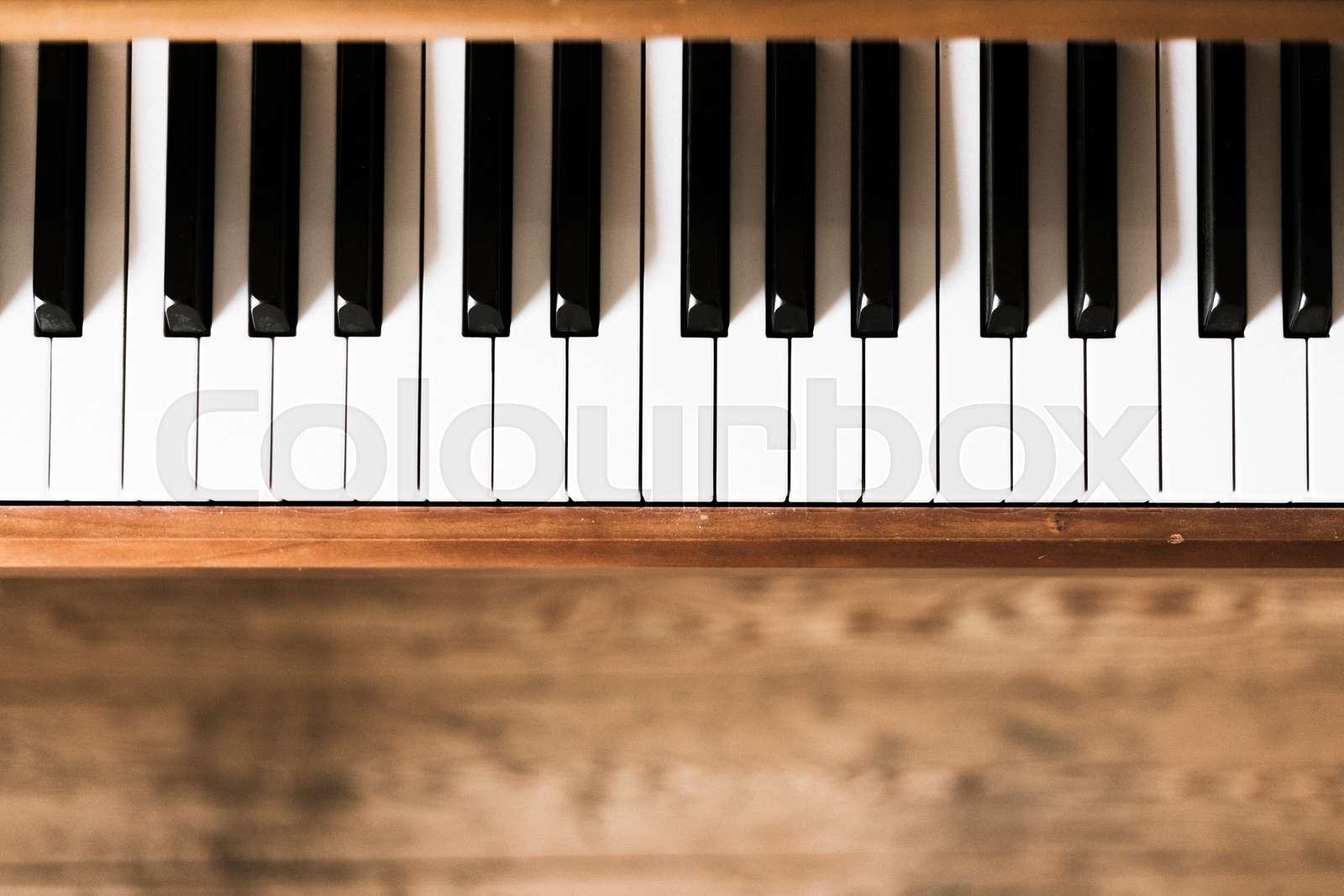 Vintage wooden piano keys, wooden blurry floor | Stock image | Colourbox
