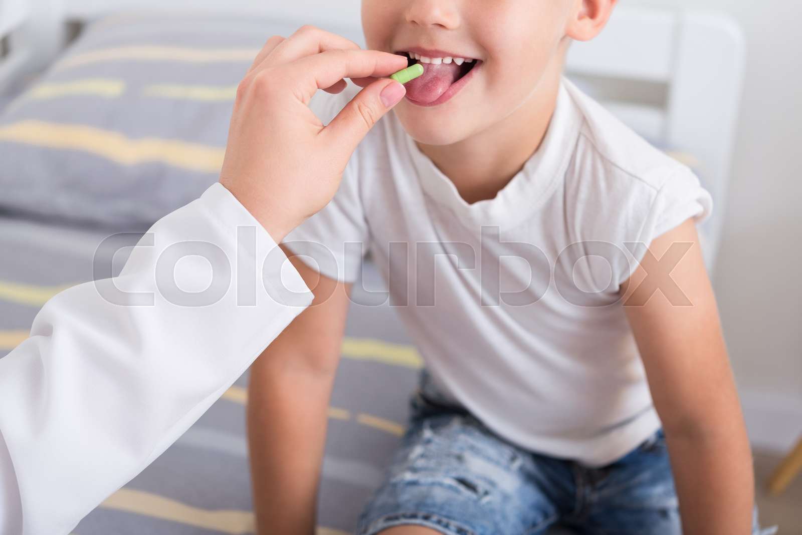 Doctor prescribes pills for a little boy. Treating a child at home ...