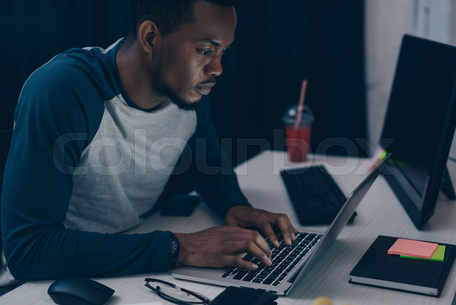 attentive african american programmer using laptop while working at ...