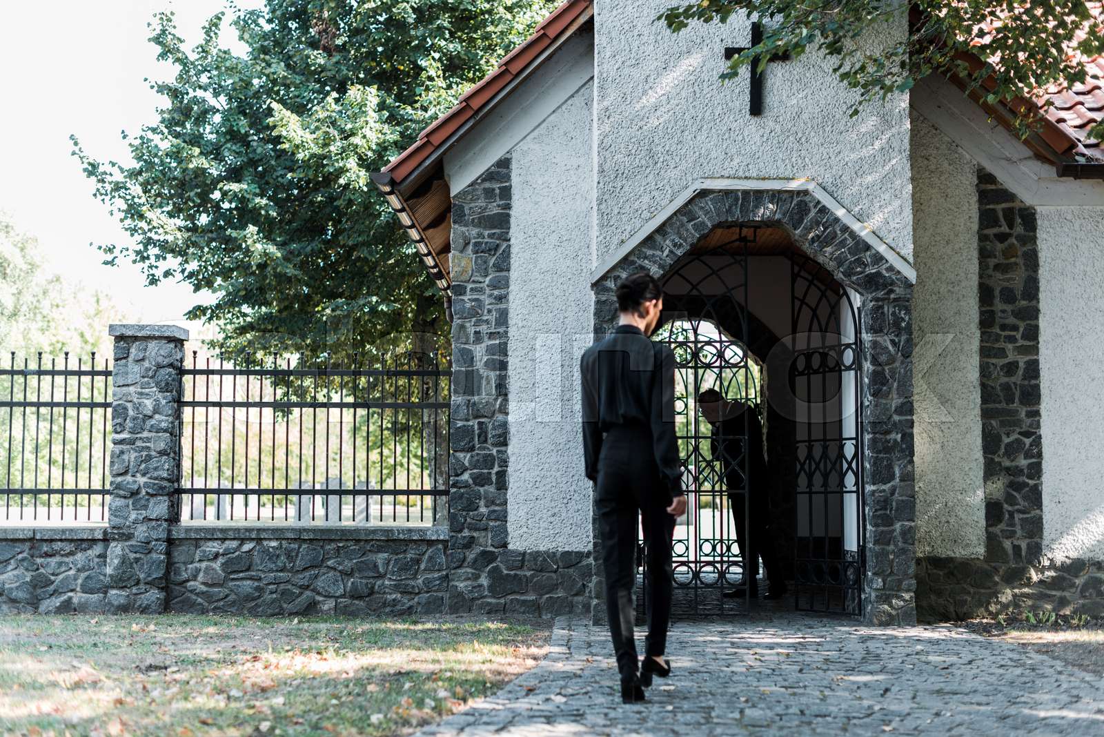 back view of woman in formal wear walking into church | Stock image ...