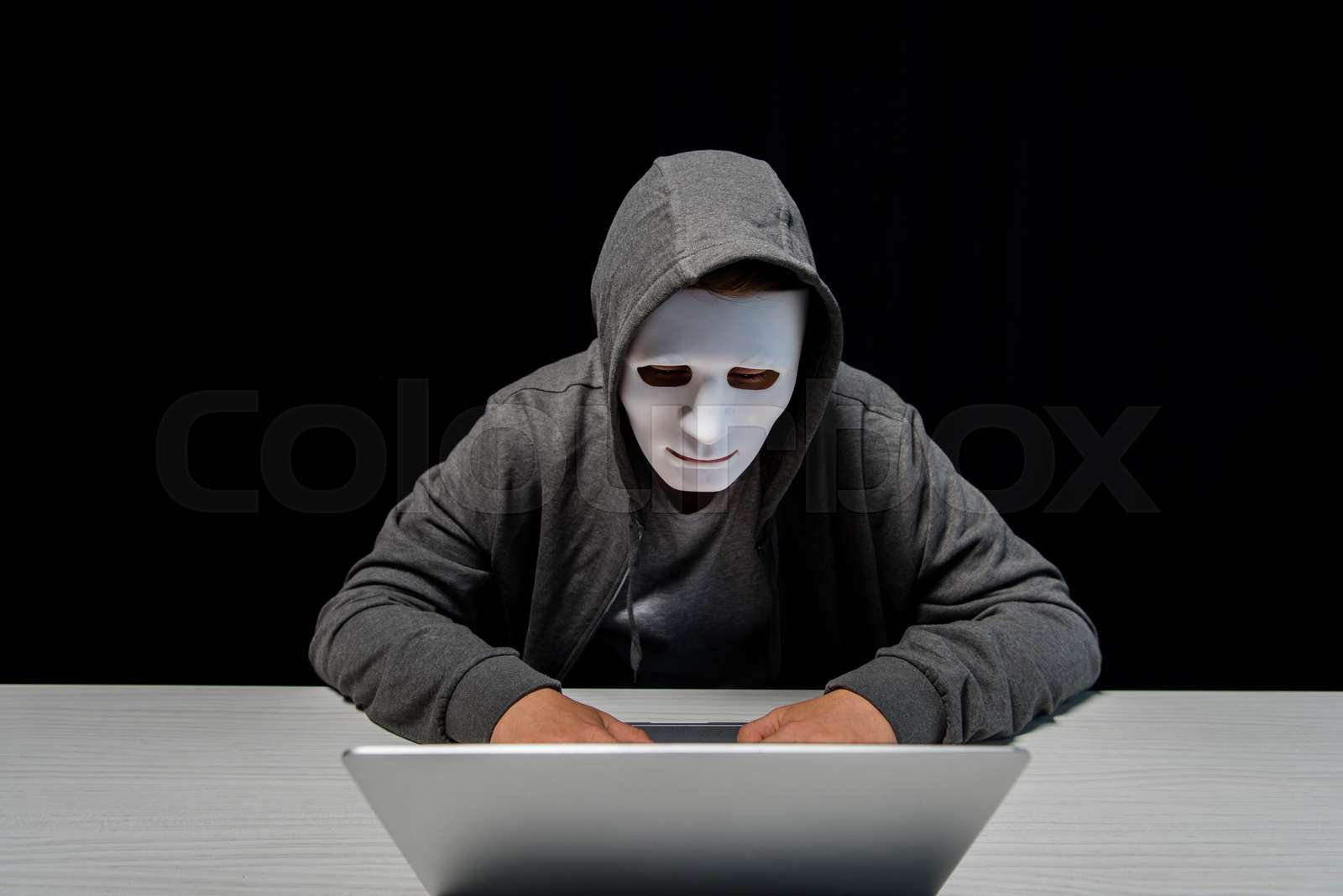 anonymous internet troll in mask typing on laptop keyboard isolated on ...