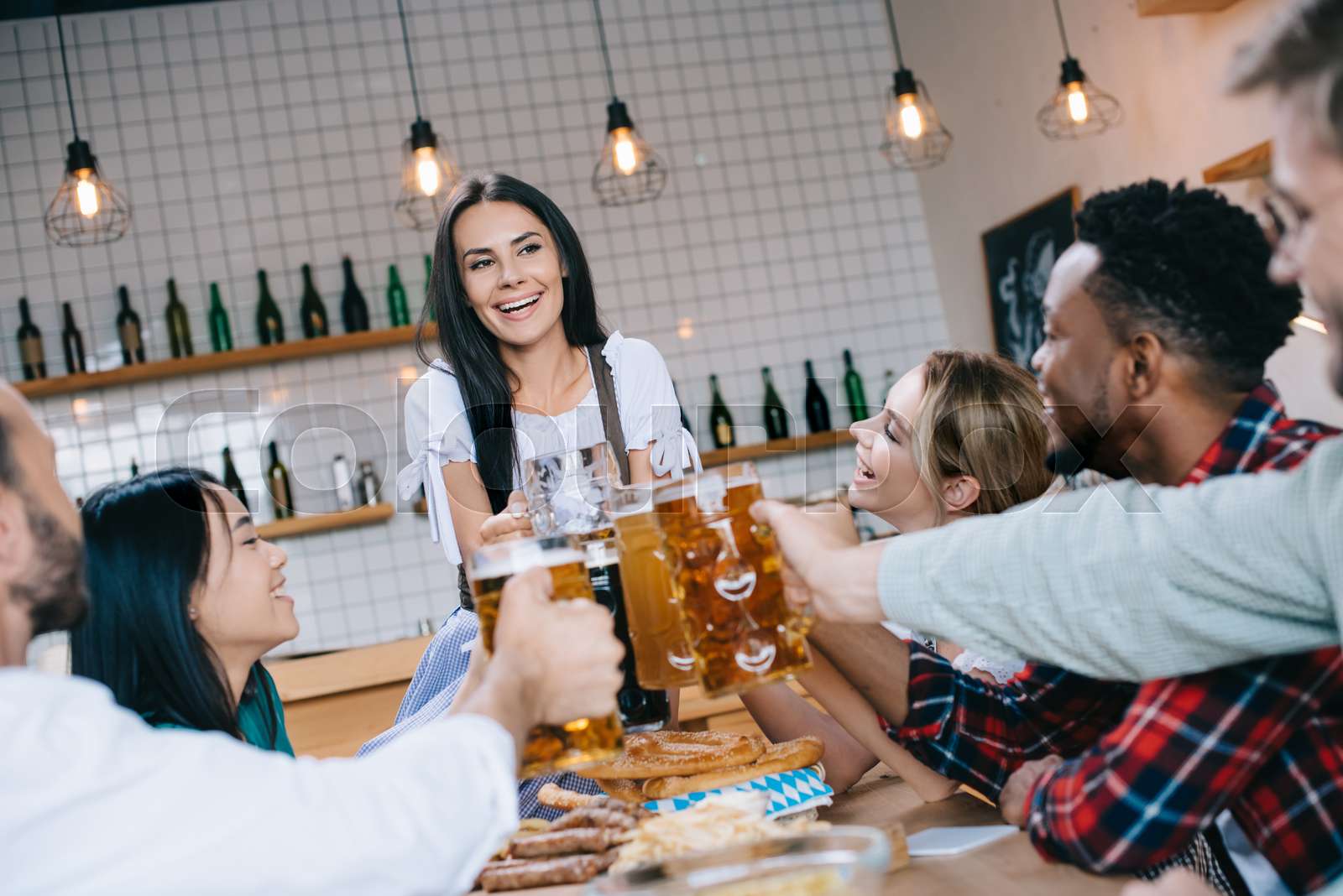 beautiful waitress in traditional german costume standing near ...