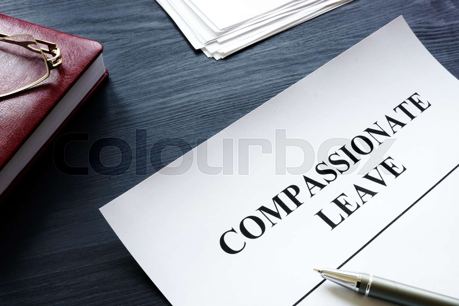 Compassionate leave request form with pen on the desk. | Stock image ...