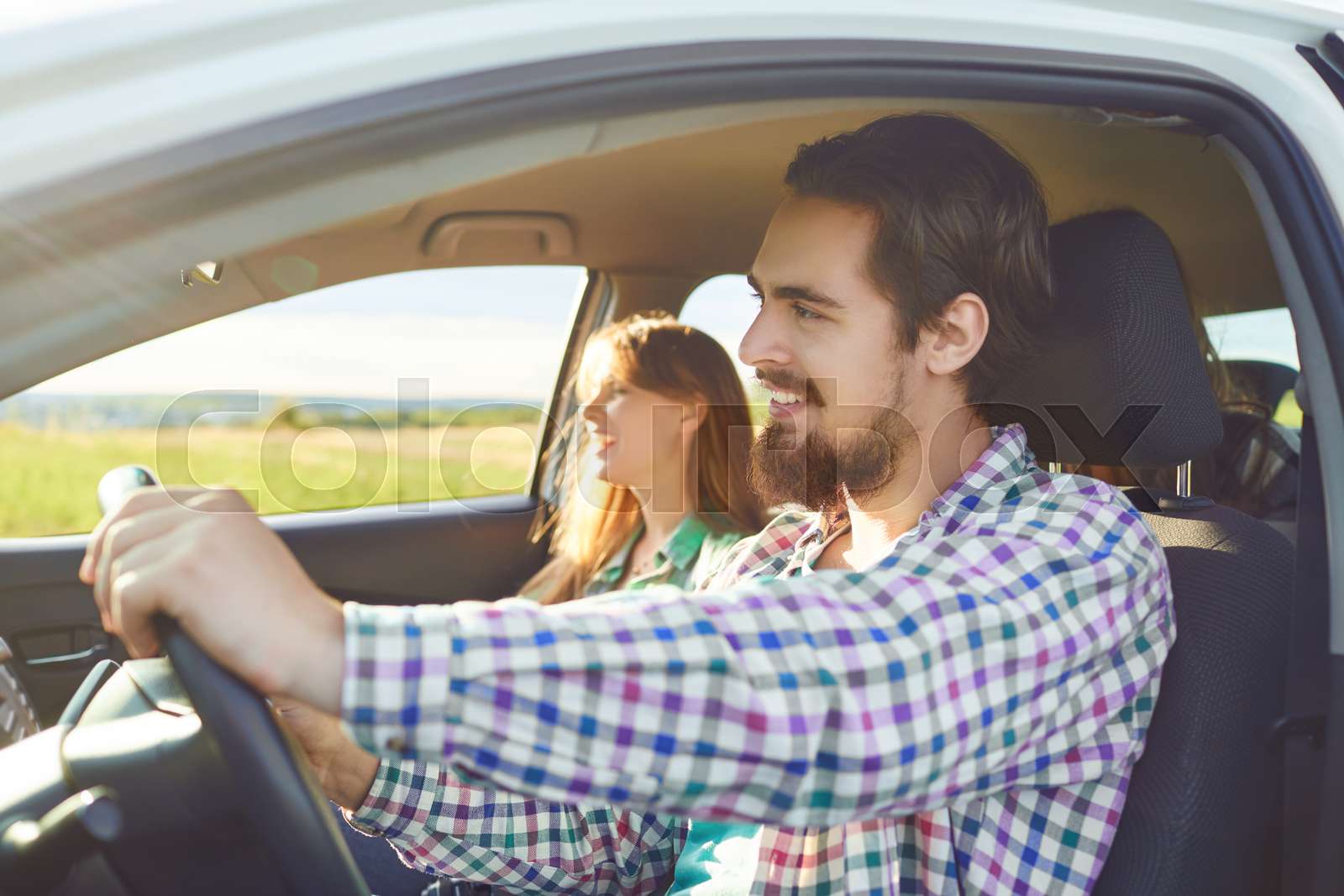 A group of happy friends are driving in a car. | Stock image | Colourbox