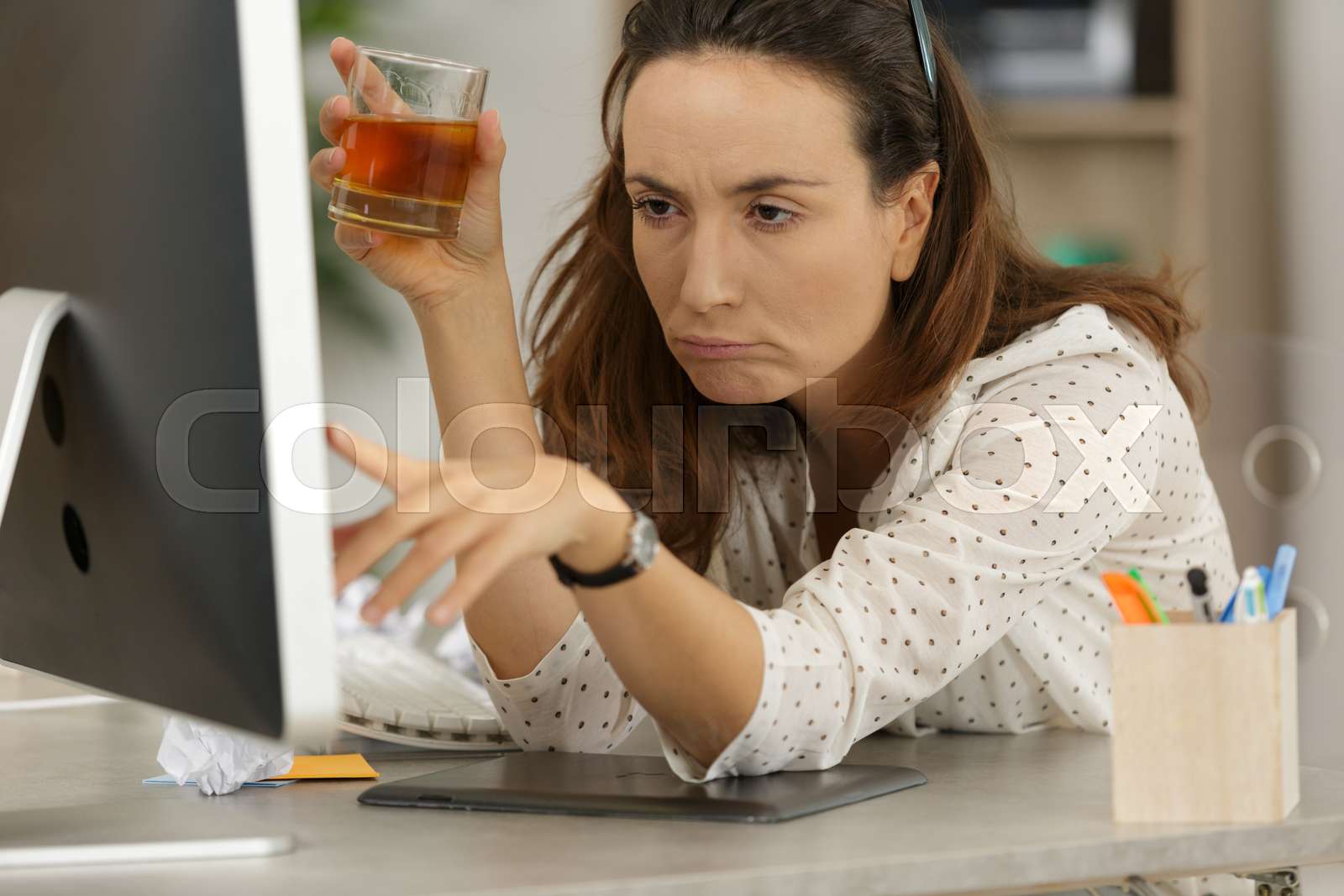 drunk young woman drinking whiskey and working on her computer | Stock ...