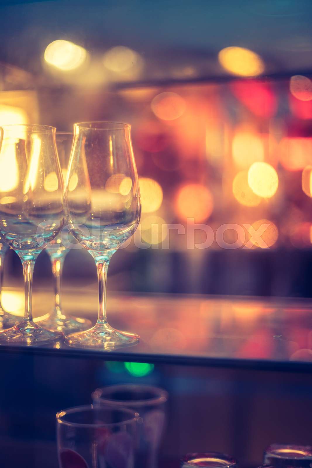 Nightlife: Wine glasses and colourful lights in a night club | Stock ...