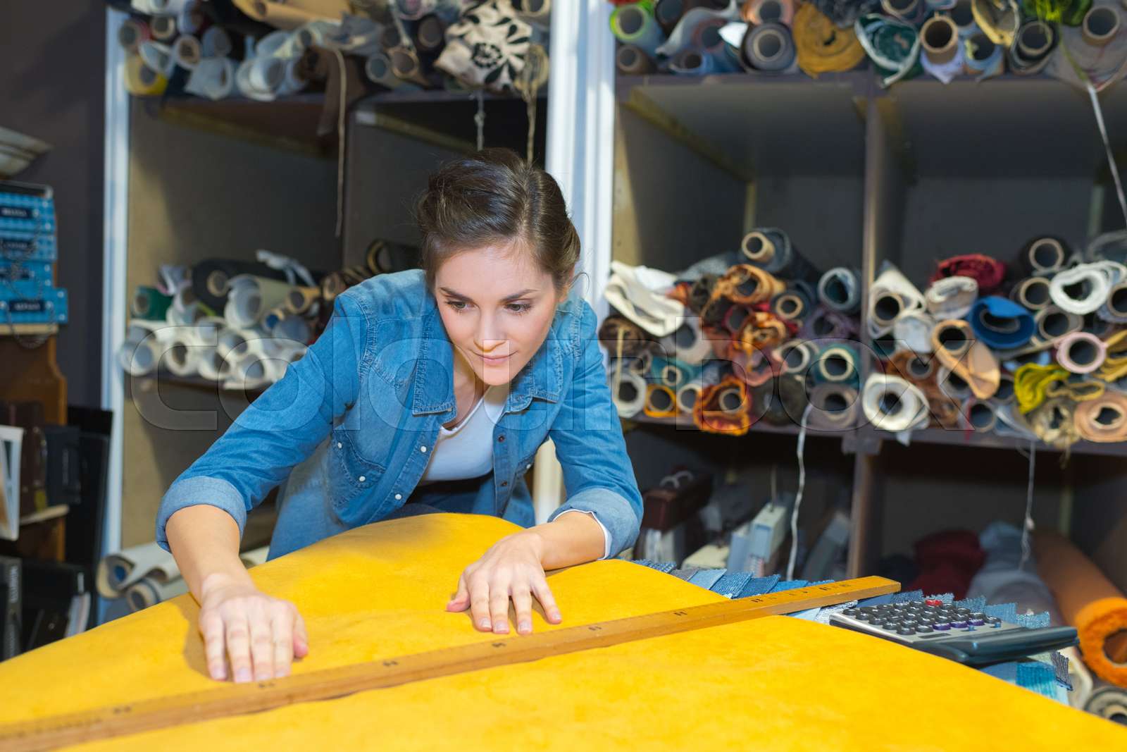 concentrated work of tailor over details of the dress | Stock image ...
