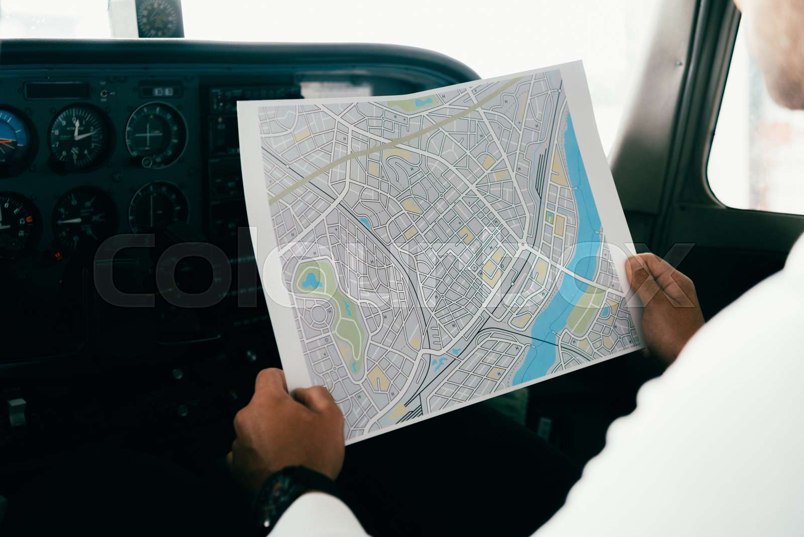 partial view of pilot holding map in plane | Stock image | Colourbox