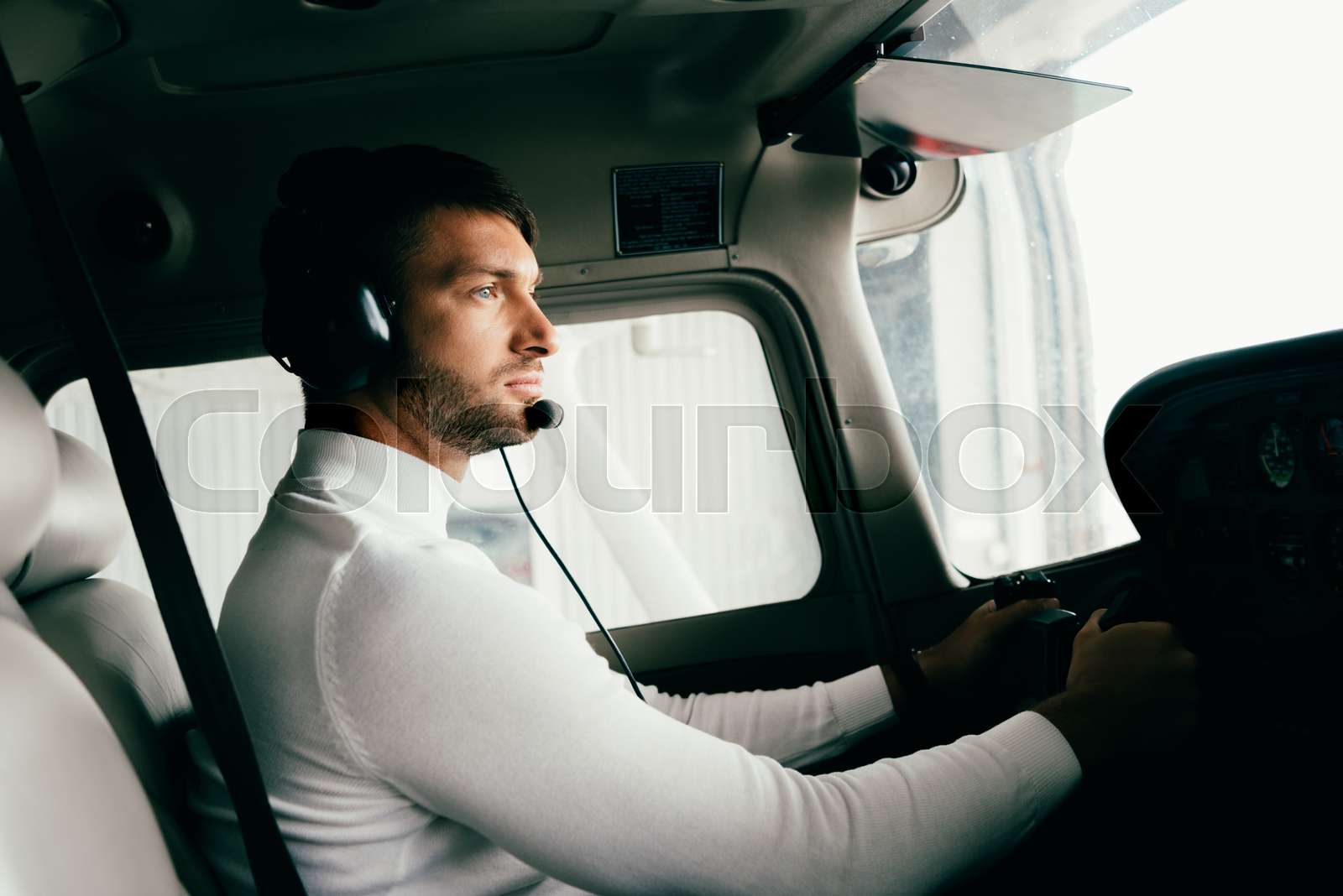 focused handsome bearded pilot in headset in plane | Stock image ...