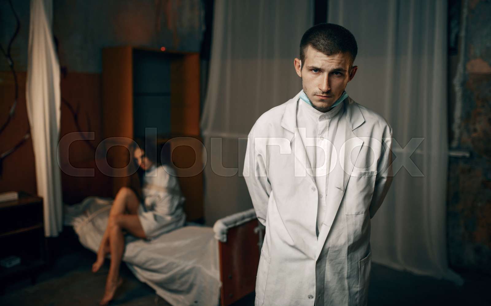 Psychiatrist and crazy patient in strait jacket | Stock image | Colourbox