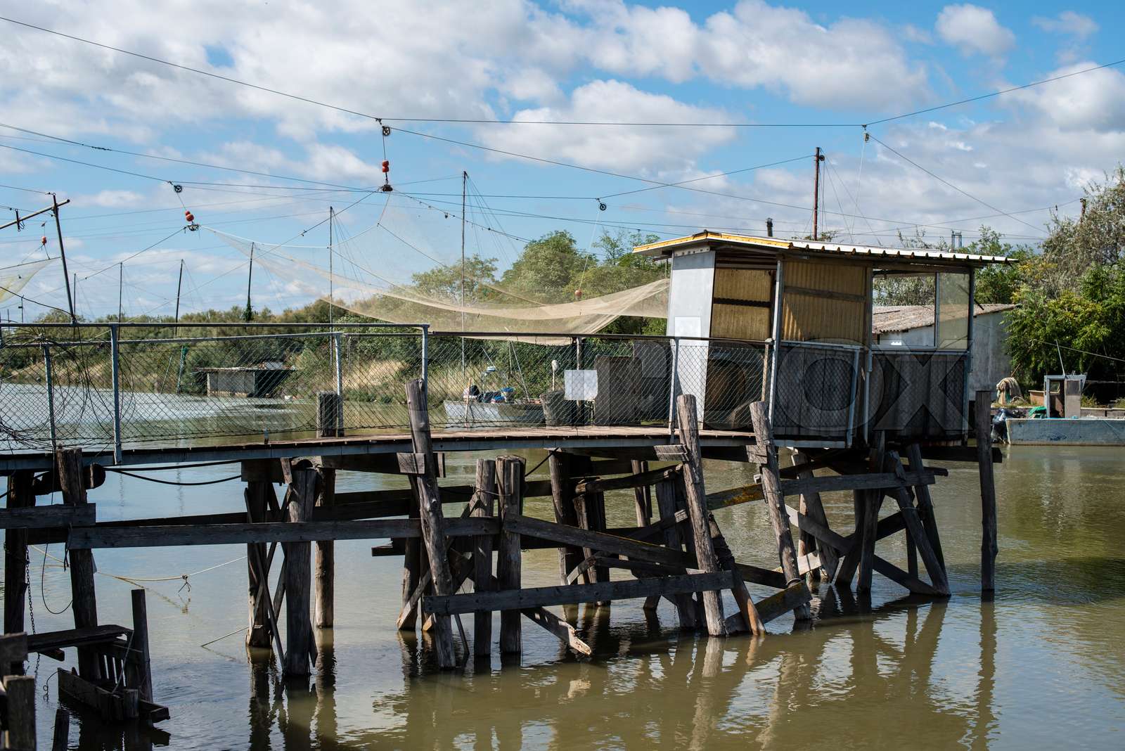 Fishing houses in dock and fishnet. | Stock image | Colourbox