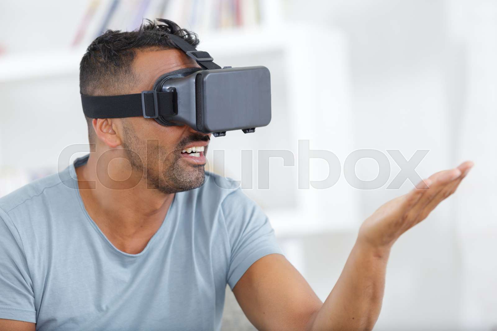 man gesturing while wearing virtual reality mask | Stock image | Colourbox