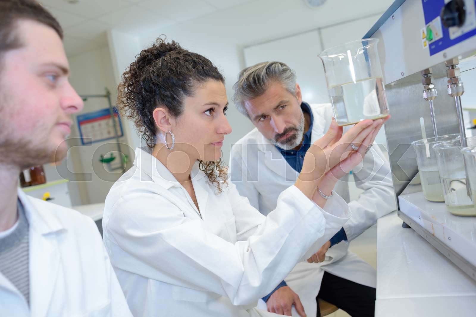 young laboratory intern holding an empty flask | Stock image | Colourbox