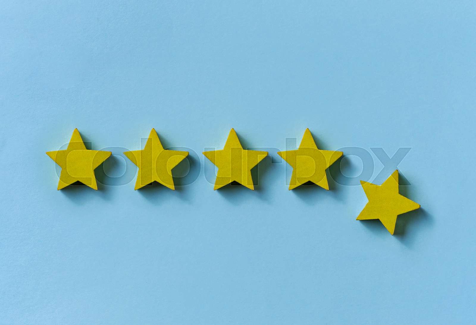 Line of five gold stars with one dropping away | Stock image | Colourbox