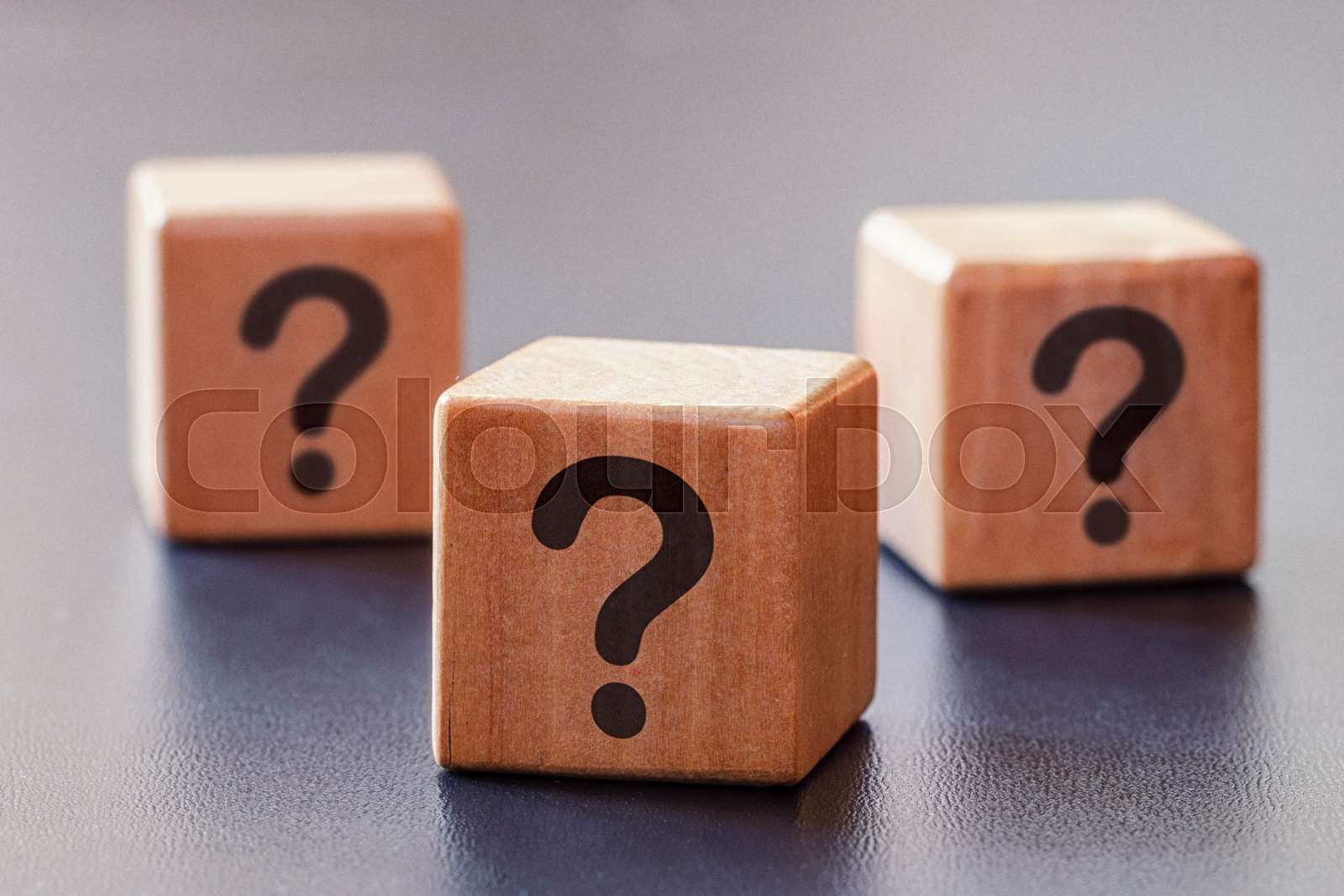 Three wooden blocks with question marks | Stock image | Colourbox
