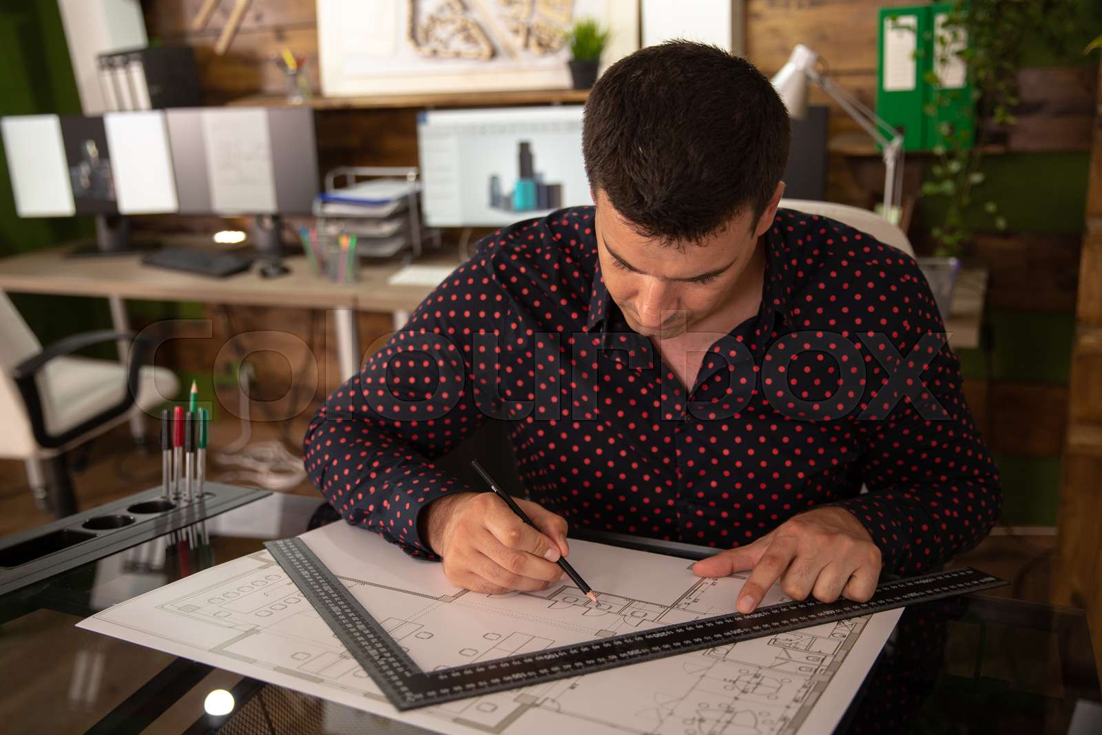 Male architect drawing a new project on the sheet | Stock image | Colourbox