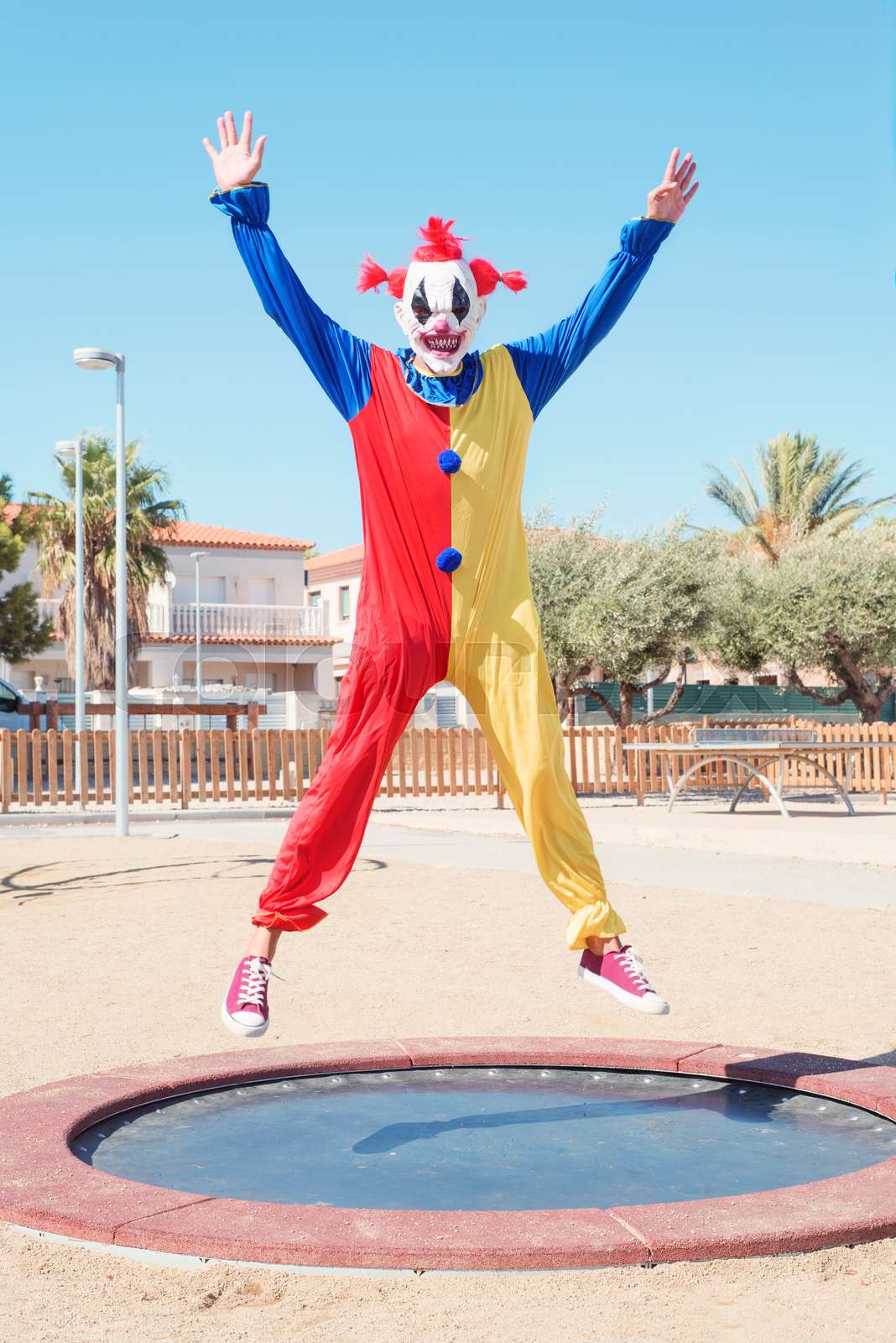 scary clown jumping outdoors | Stock image | Colourbox