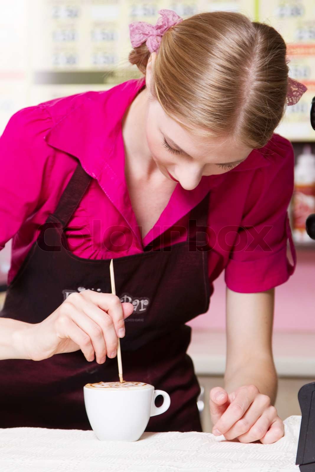 Friendly waitress making coffee | Stock image | Colourbox