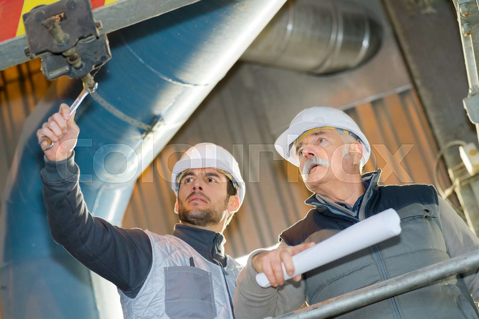 worker tightening bolt with socket on industrial site | Stock image ...
