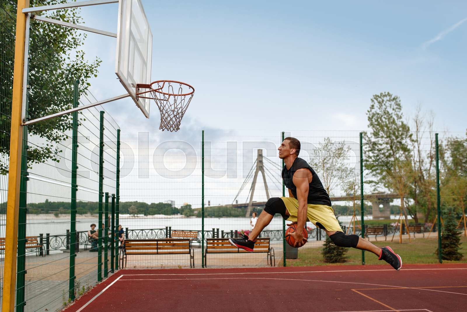 Basketball player makes a throw in jump, outdoor | Stock image | Colourbox