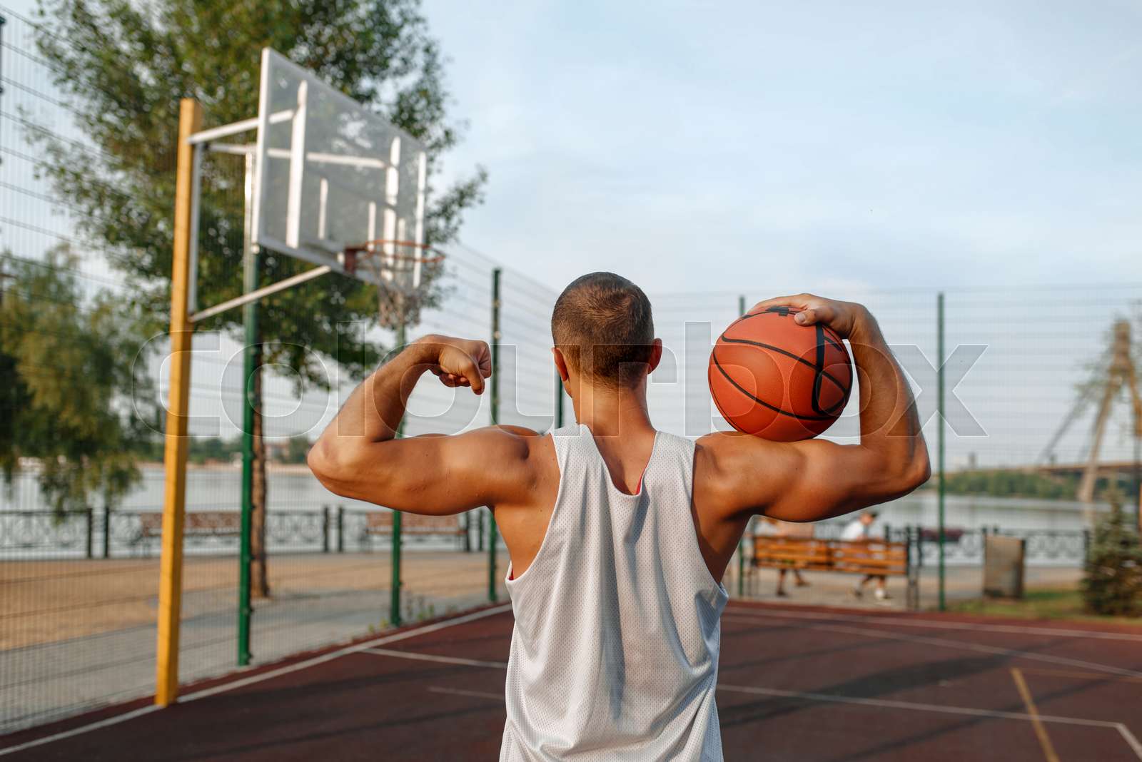 Male basketball player with ball shows his muscles | Stock image ...