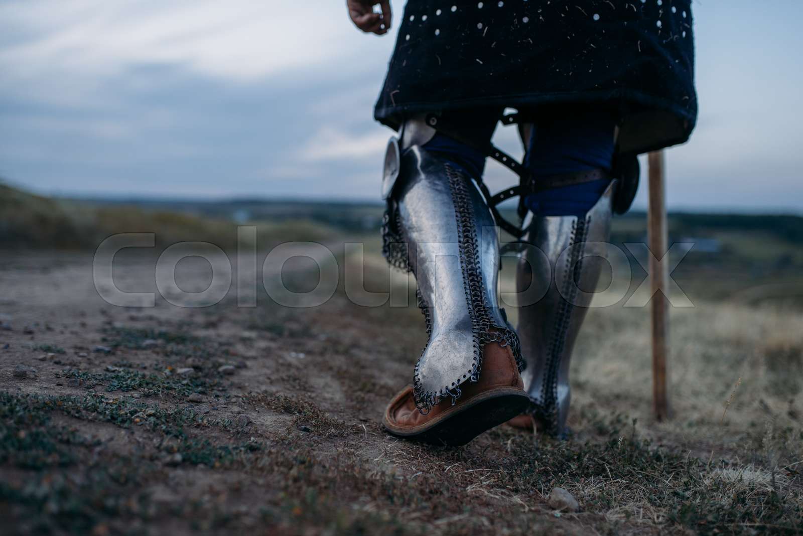 Medieval knight legs in metal armor, back view | Stock image | Colourbox